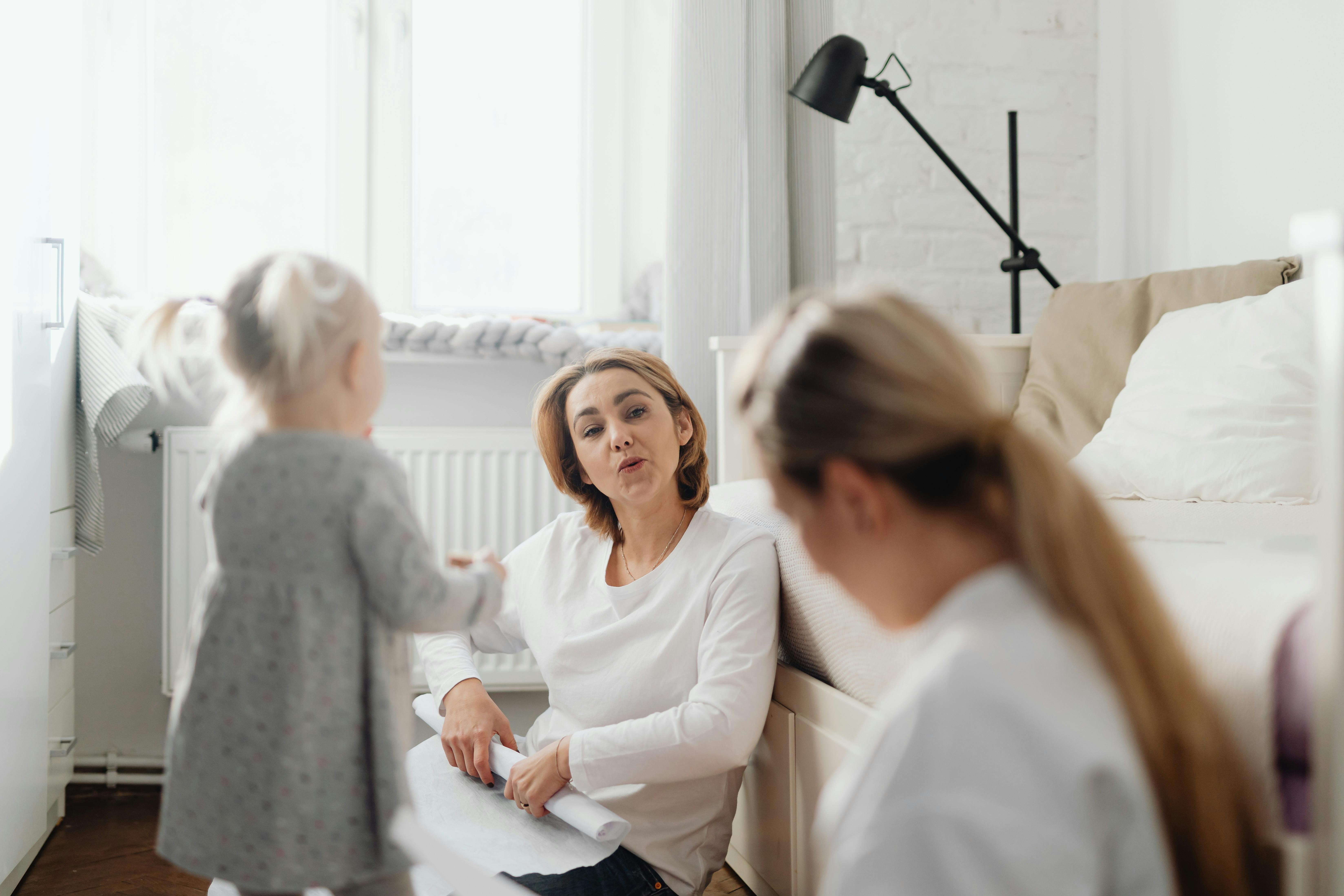 Women Talking with Girl in Room · Free Stock Photo
