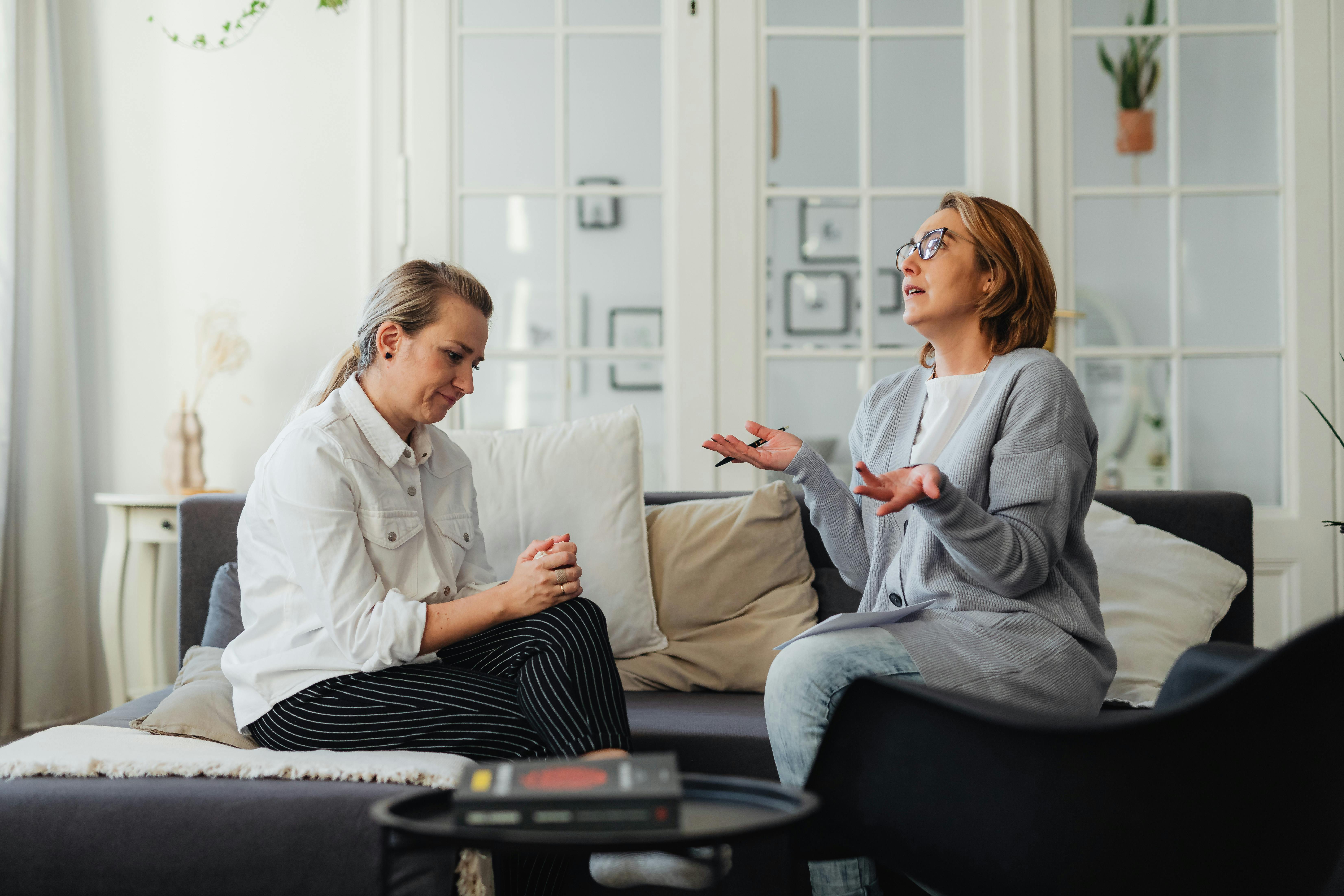 Two Women Talking in a Living Room · Free Stock Photo