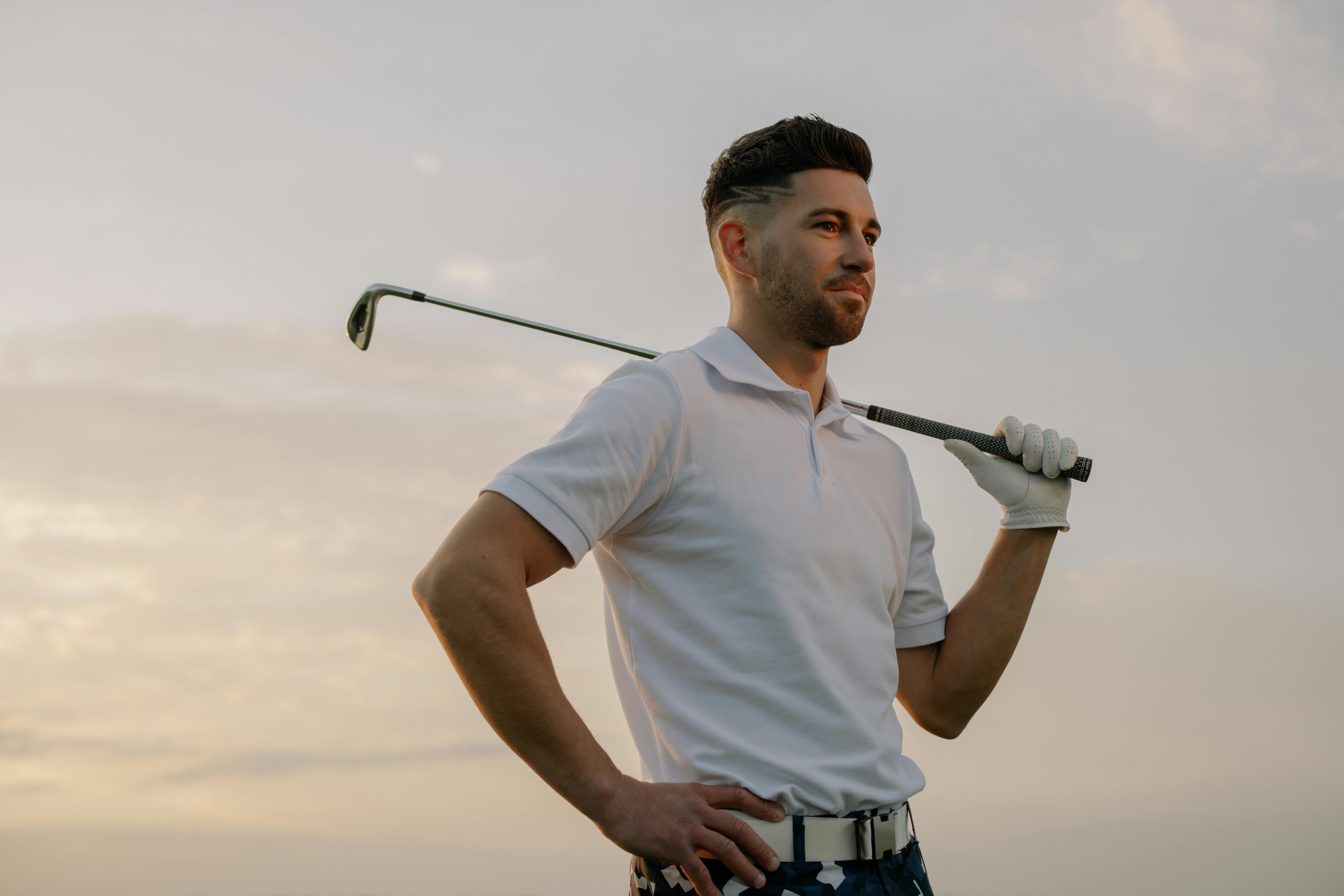 A Man Holding a Golf Club · Free Stock Photo