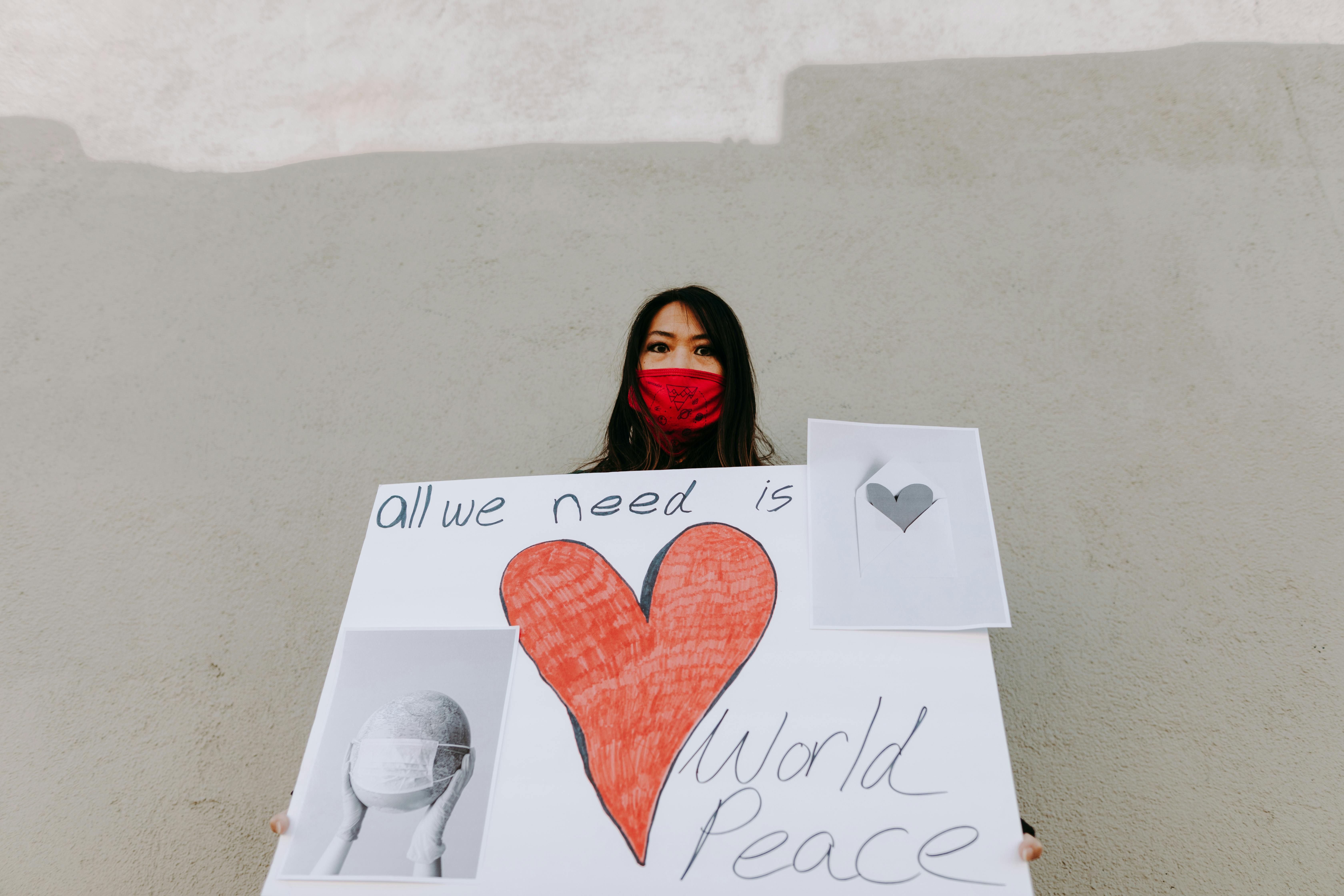 A Woman in Face Mask Holding White Placards · Free Stock Photo