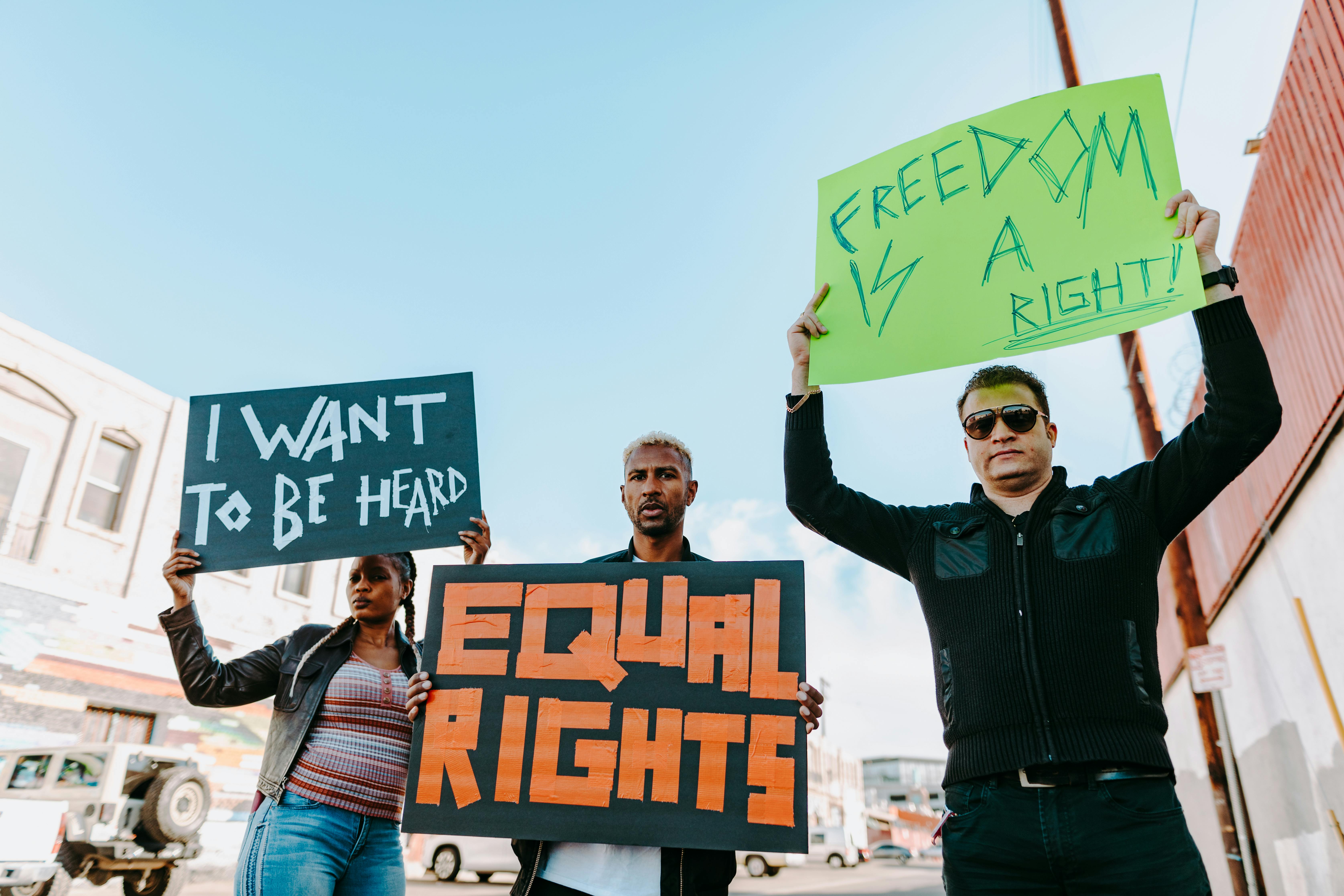 A People Protesting While Holding Banner · Free Stock Photo