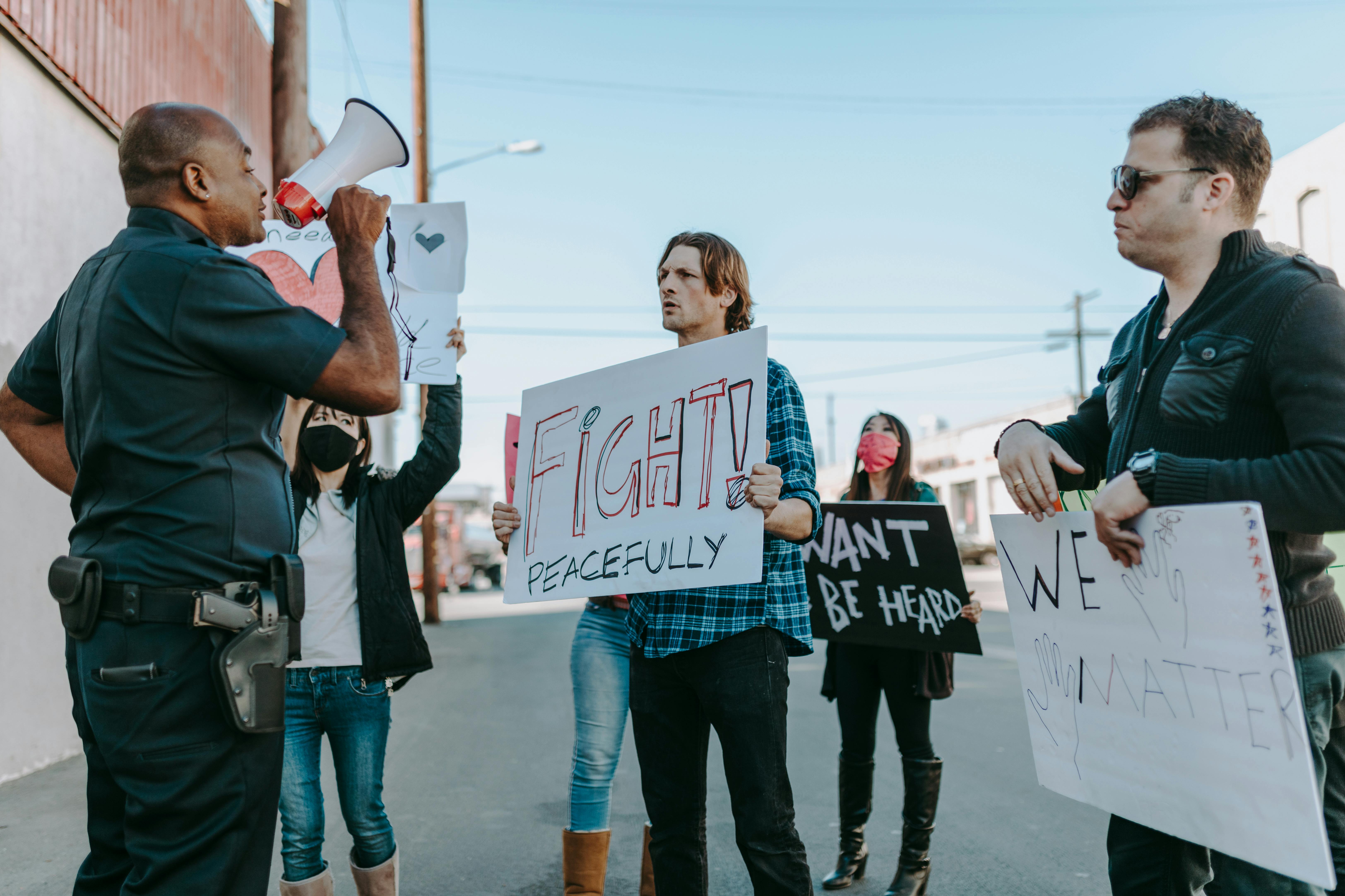 A Police Talking the Protesters · Free Stock Photo
