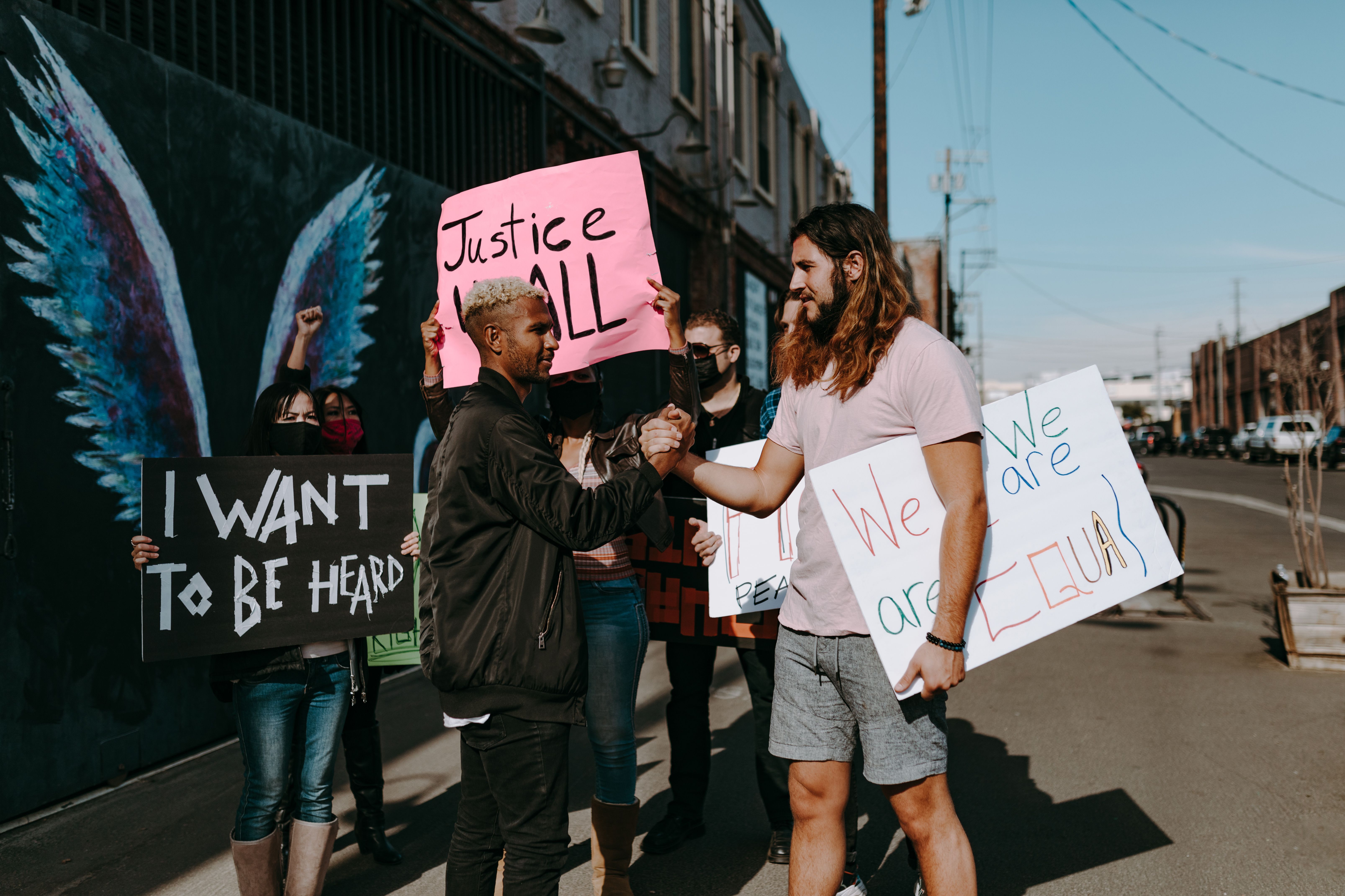 People Holding Protest Banners · Free Stock Photo