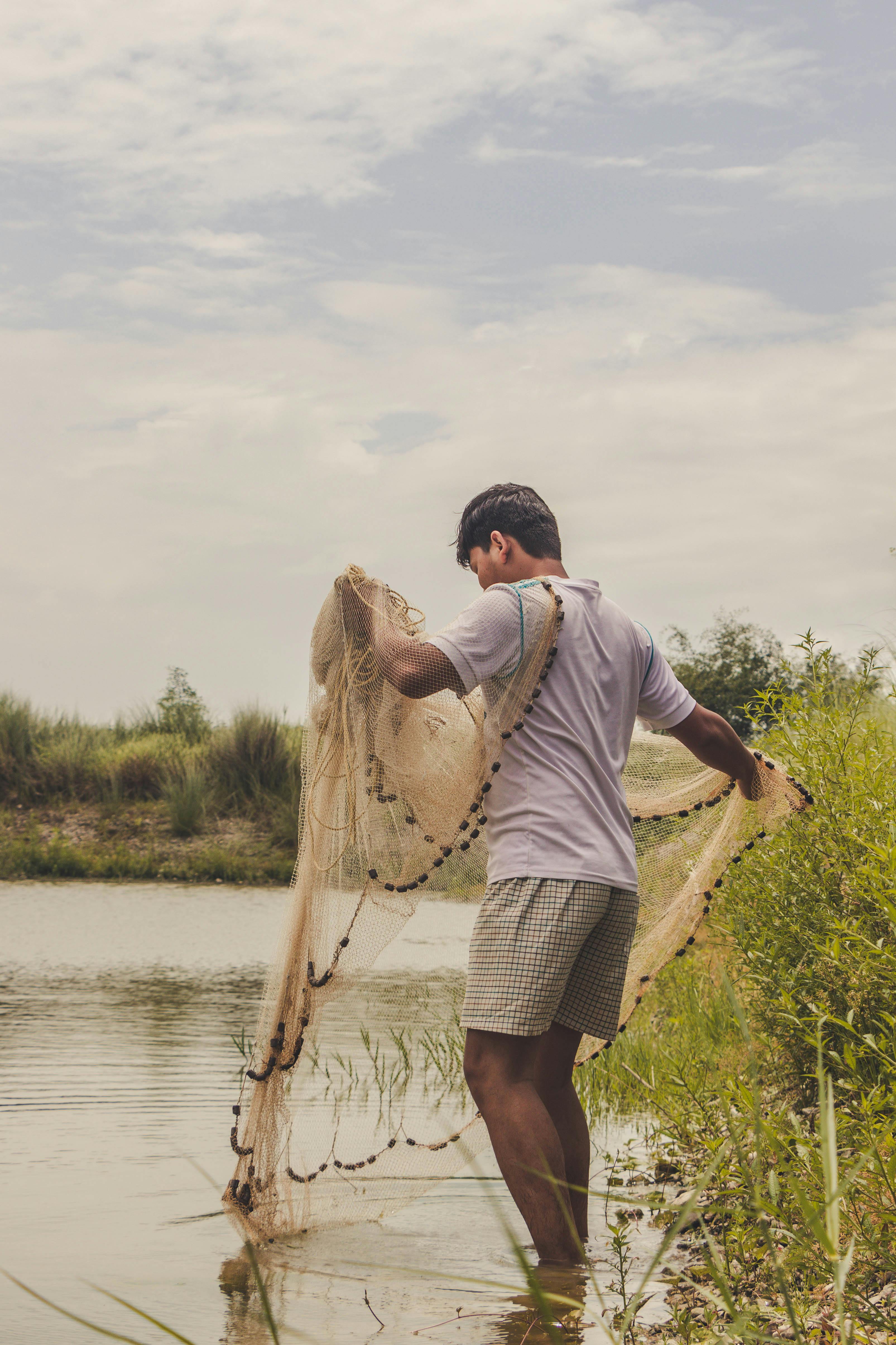 A Man Holding a Carp Fish · Free Stock Photo