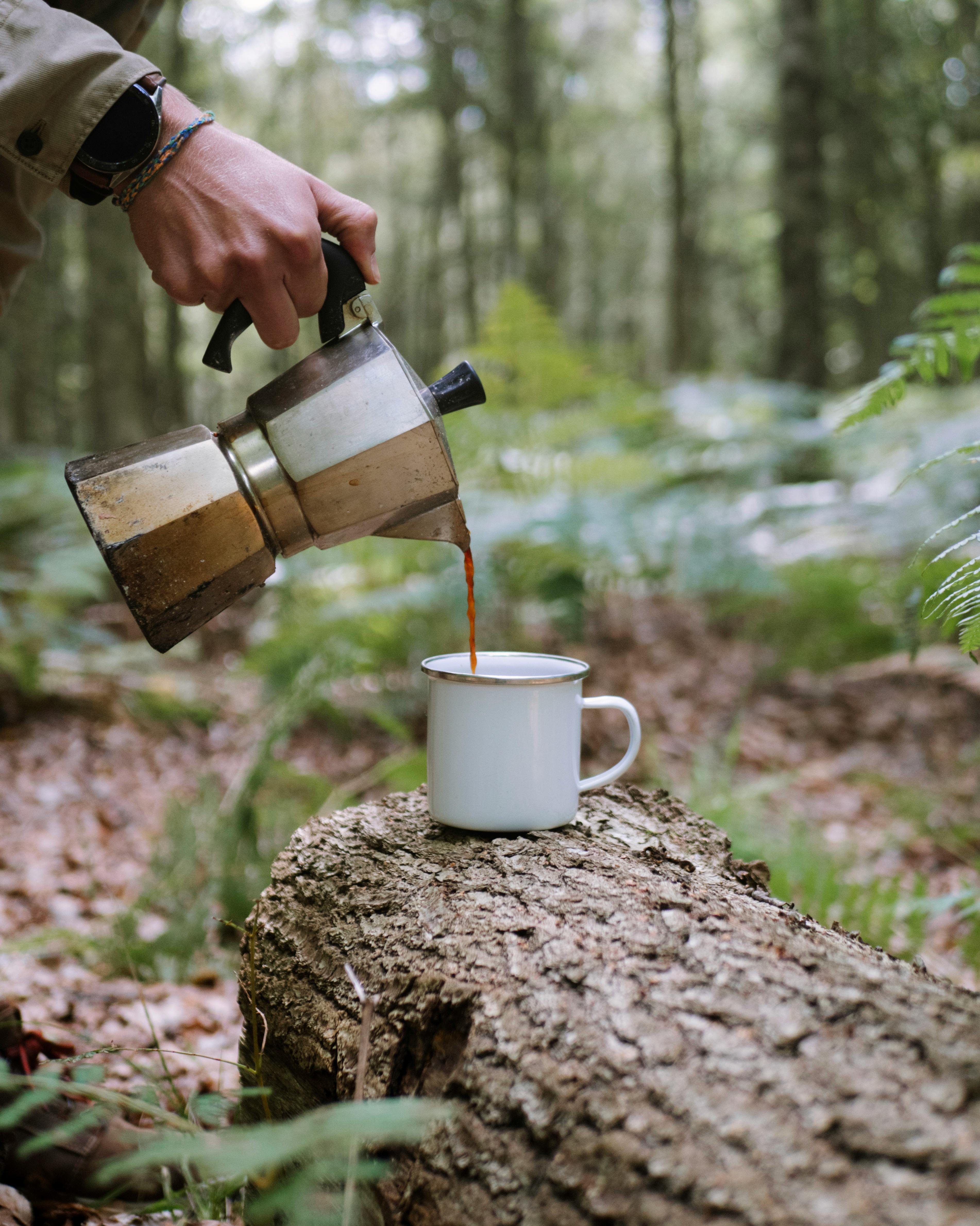 A Man Pouring Hot Coffee in a Cup · Free Stock Photo