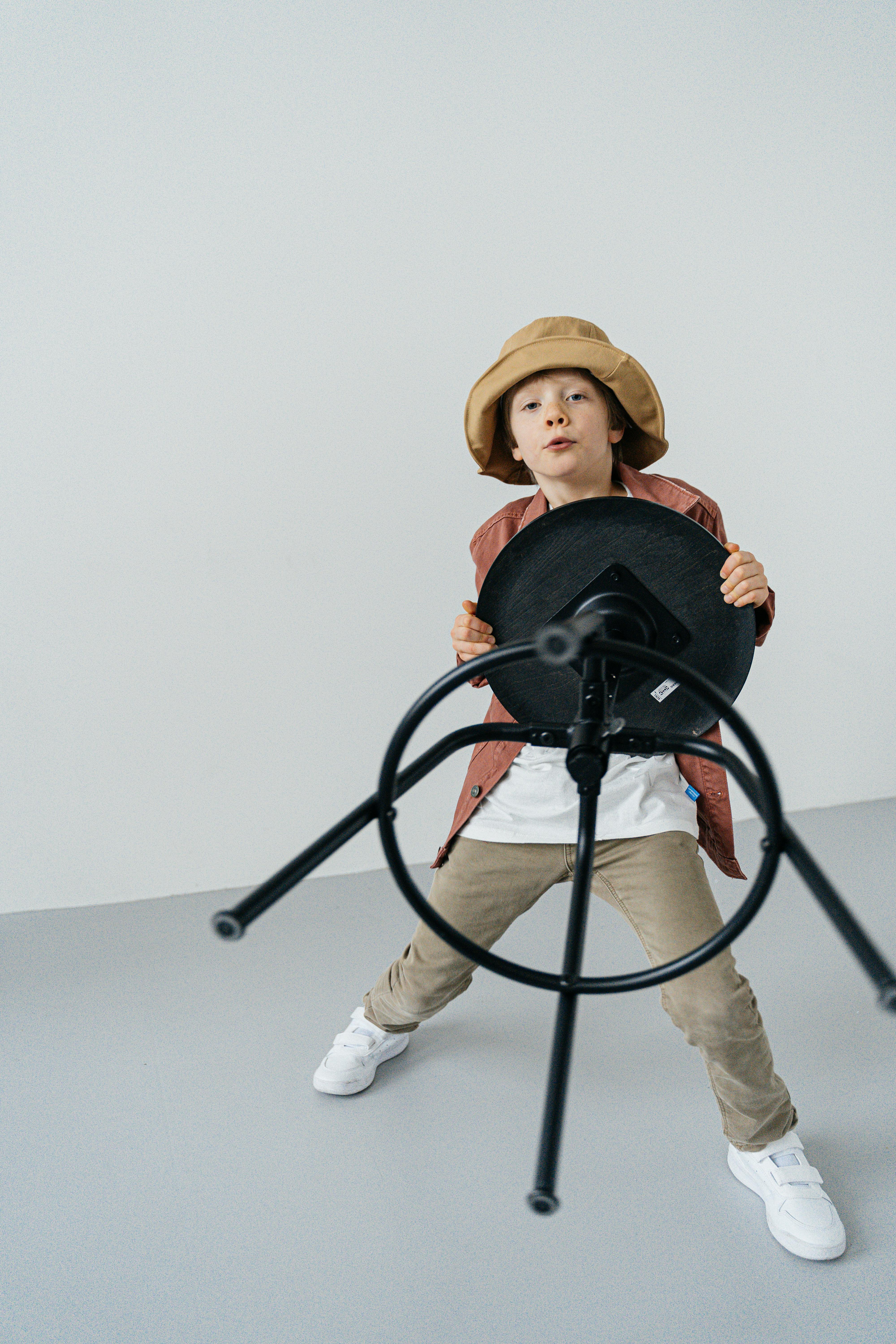 A Boy Carrying a Chair · Free Stock Photo