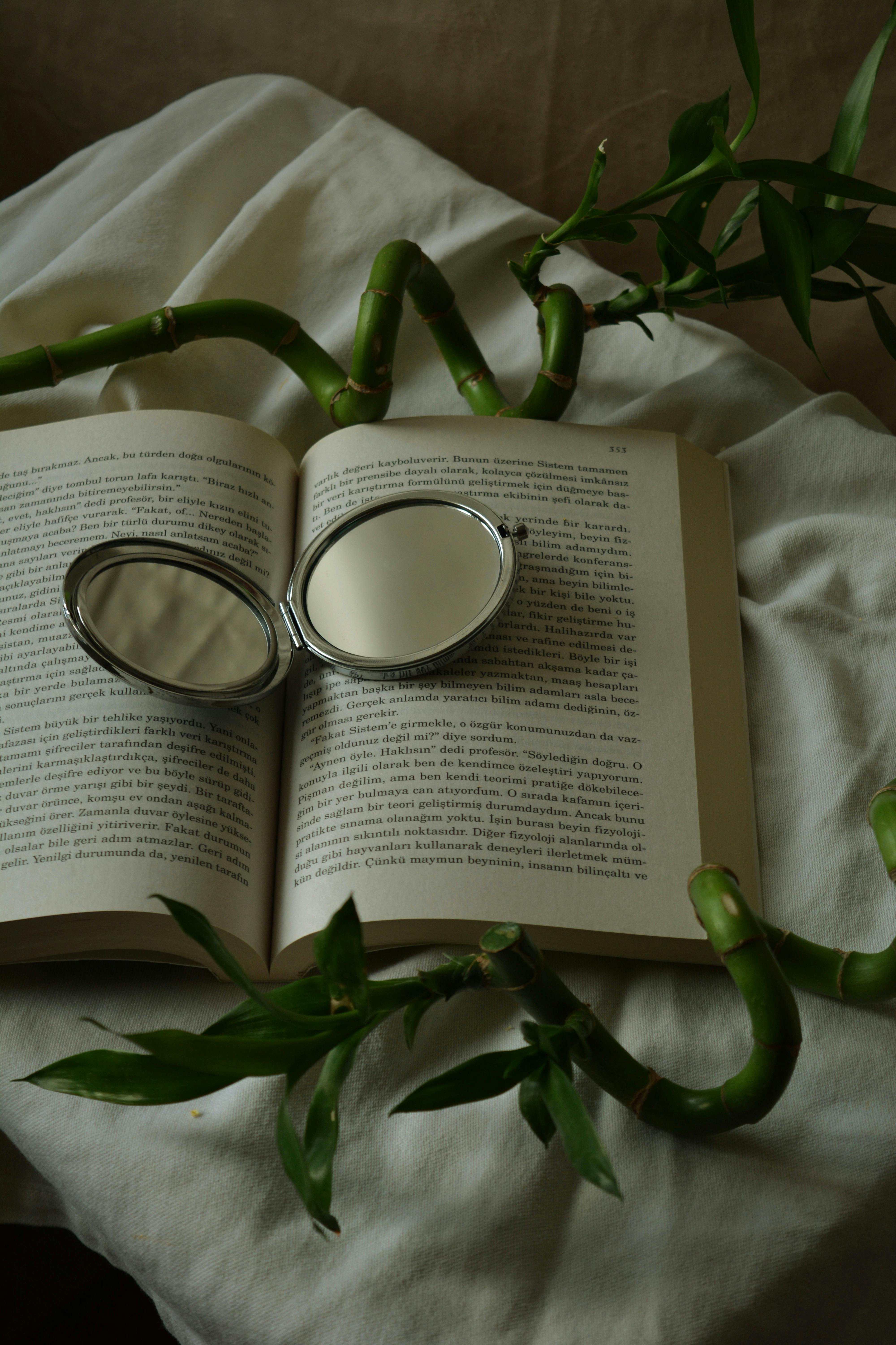 Round Mirror on Top of a Book · Free Stock Photo