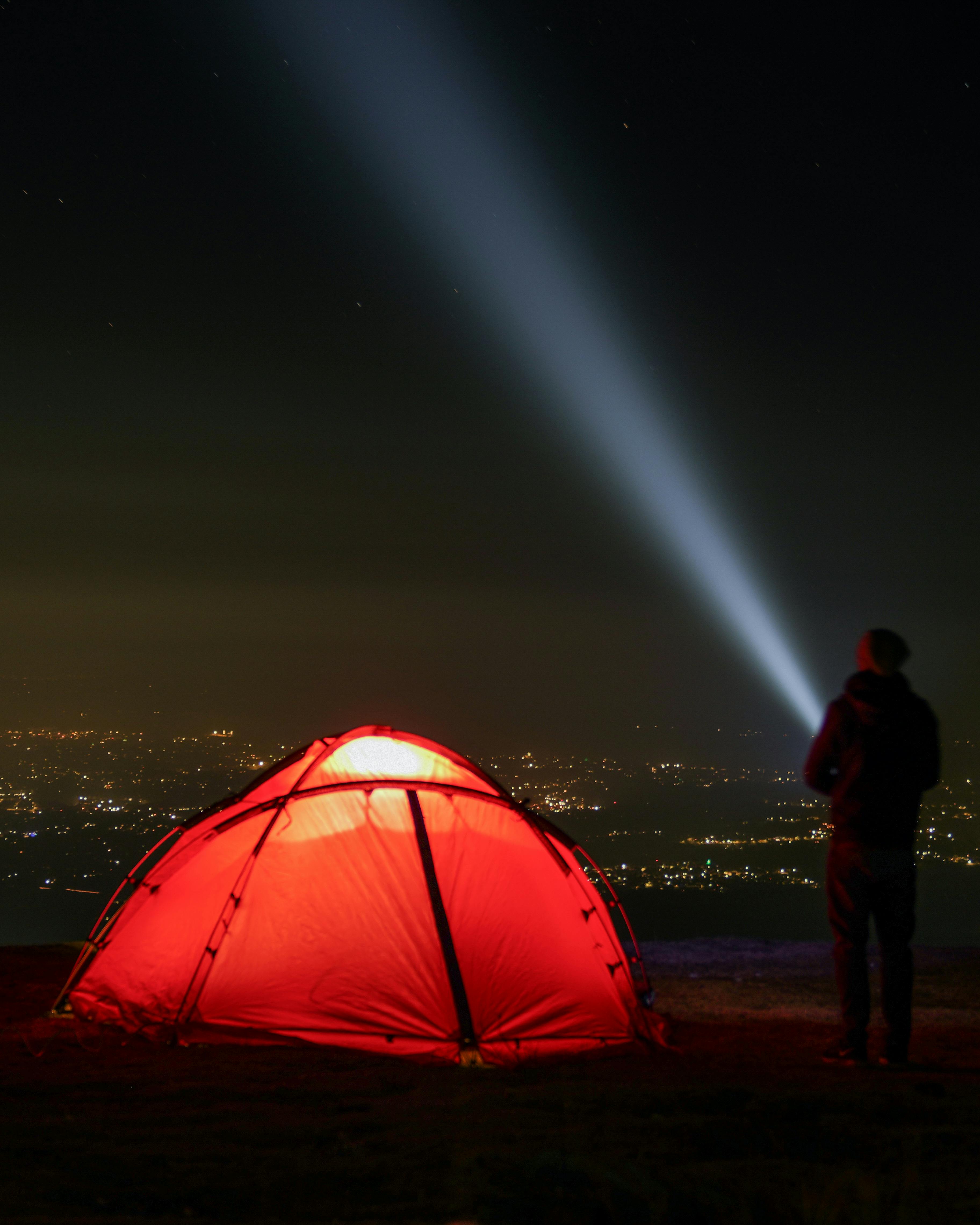 Man Standing Near a Tent during Night Time · Free Stock Photo