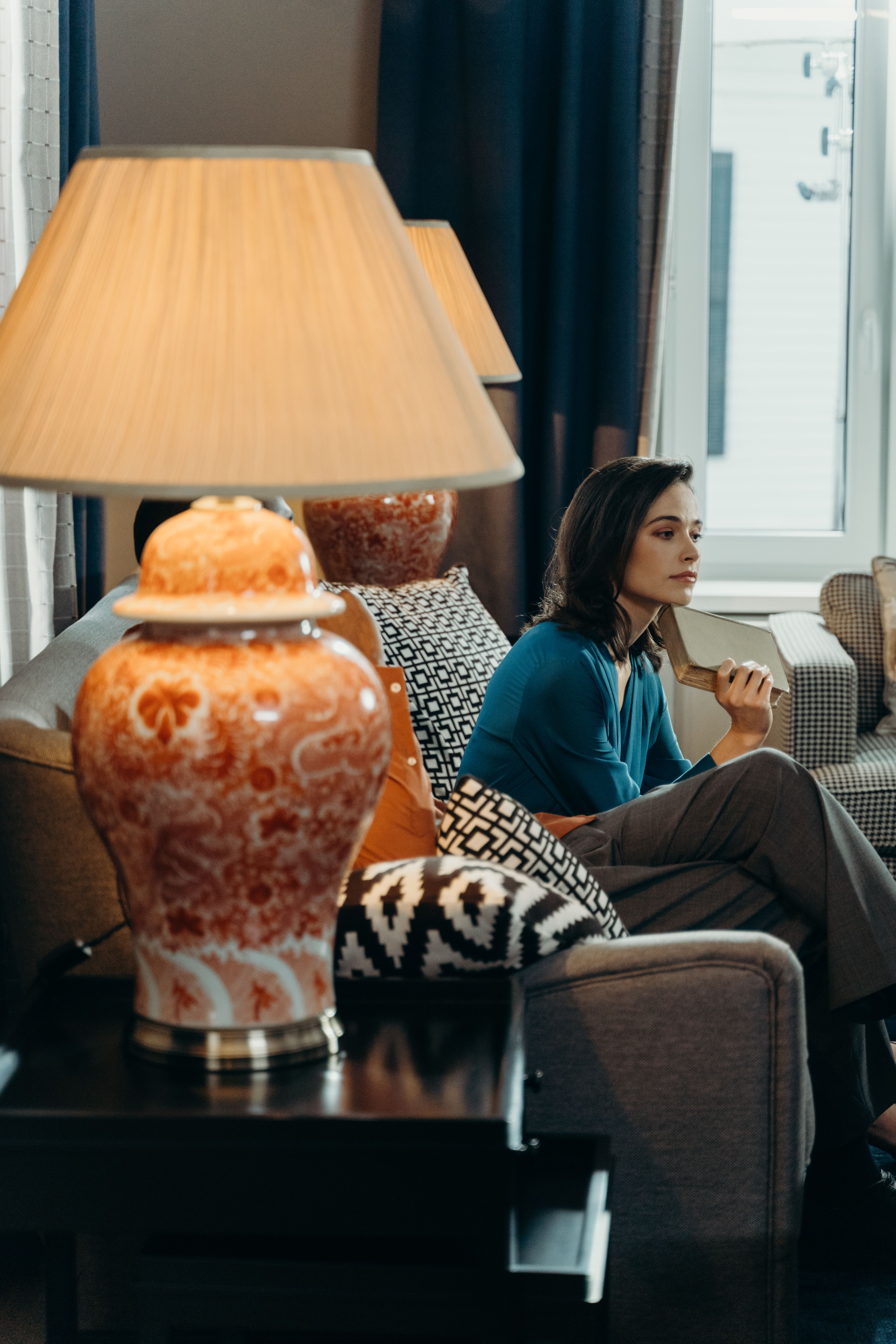 Woman Wearing Blue Dress Reclining on Sofa Reading Book · Free Stock Photo
