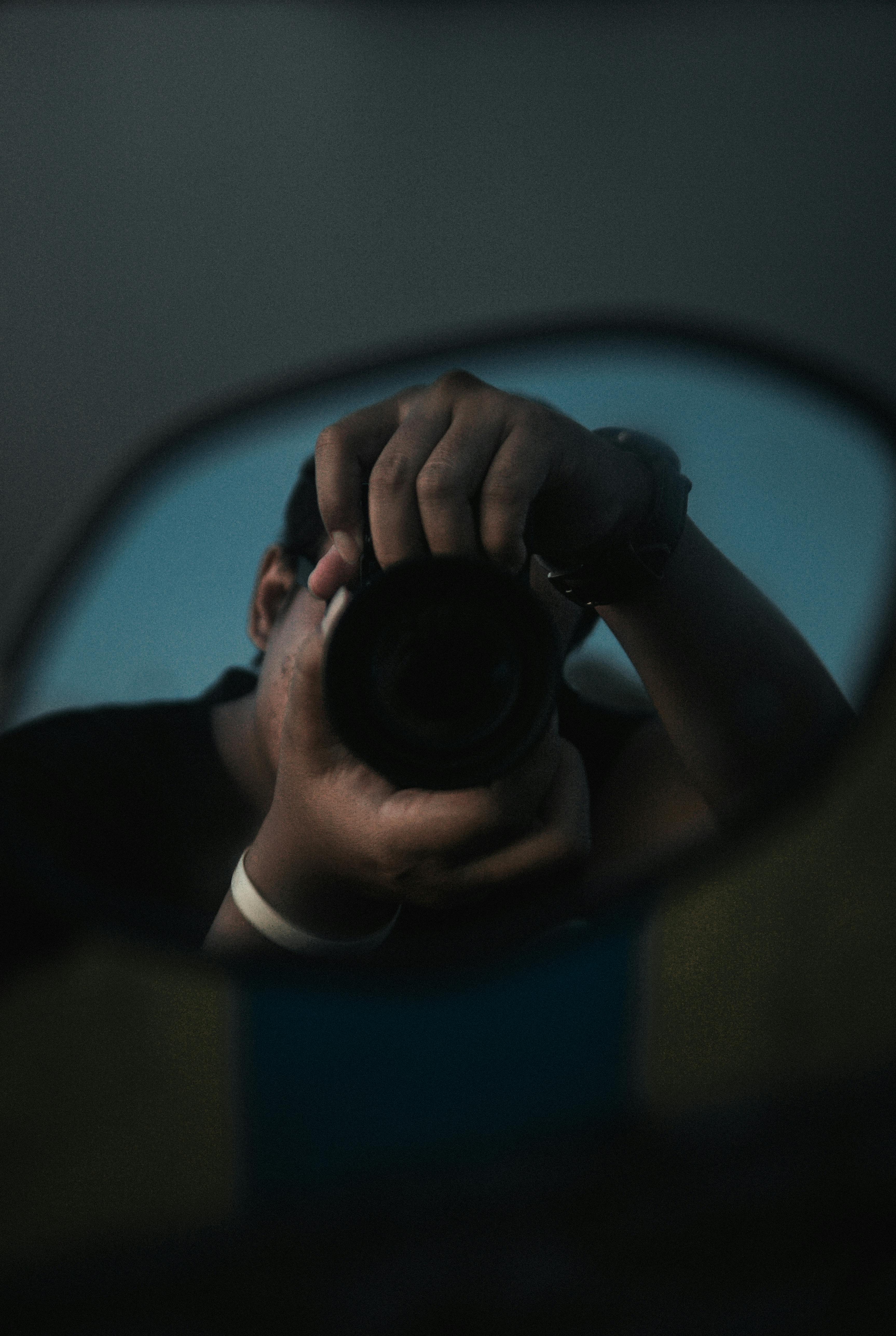 Monochrome Photo of Man Capturing His Reflection · Free Stock Photo