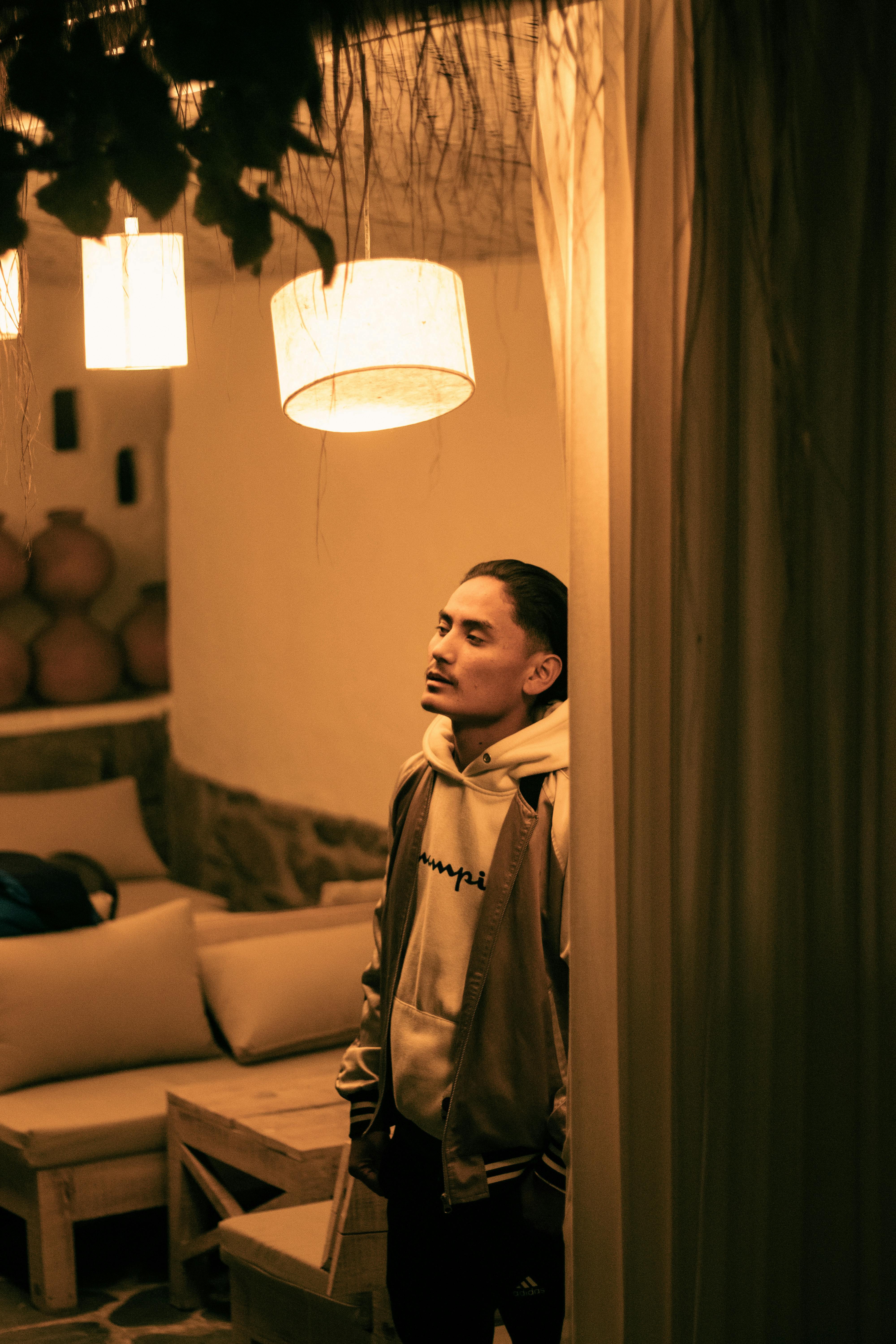 A Young Man Standing in a Room · Free Stock Photo
