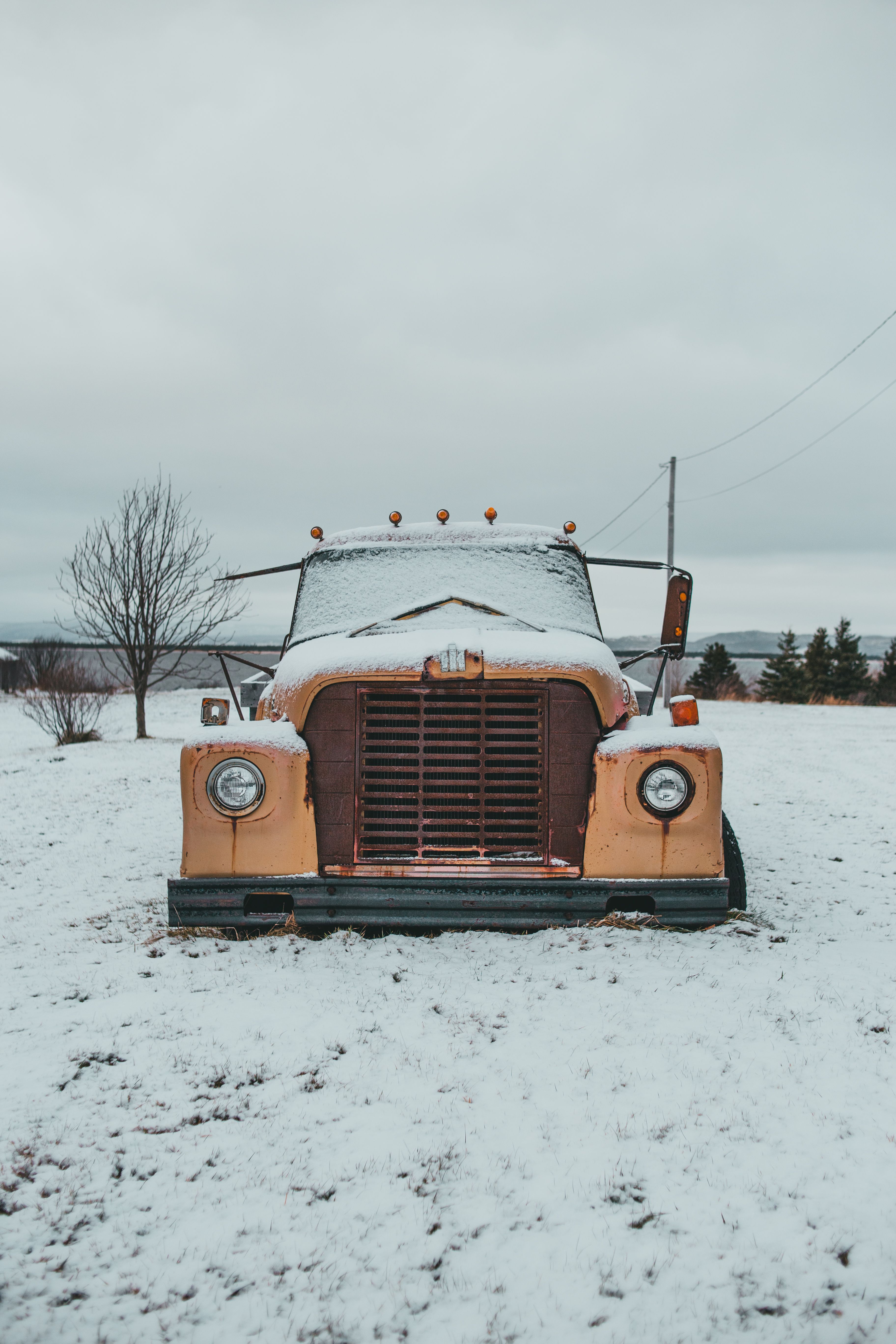 Truck on snowy ground near building · Free Stock Photo