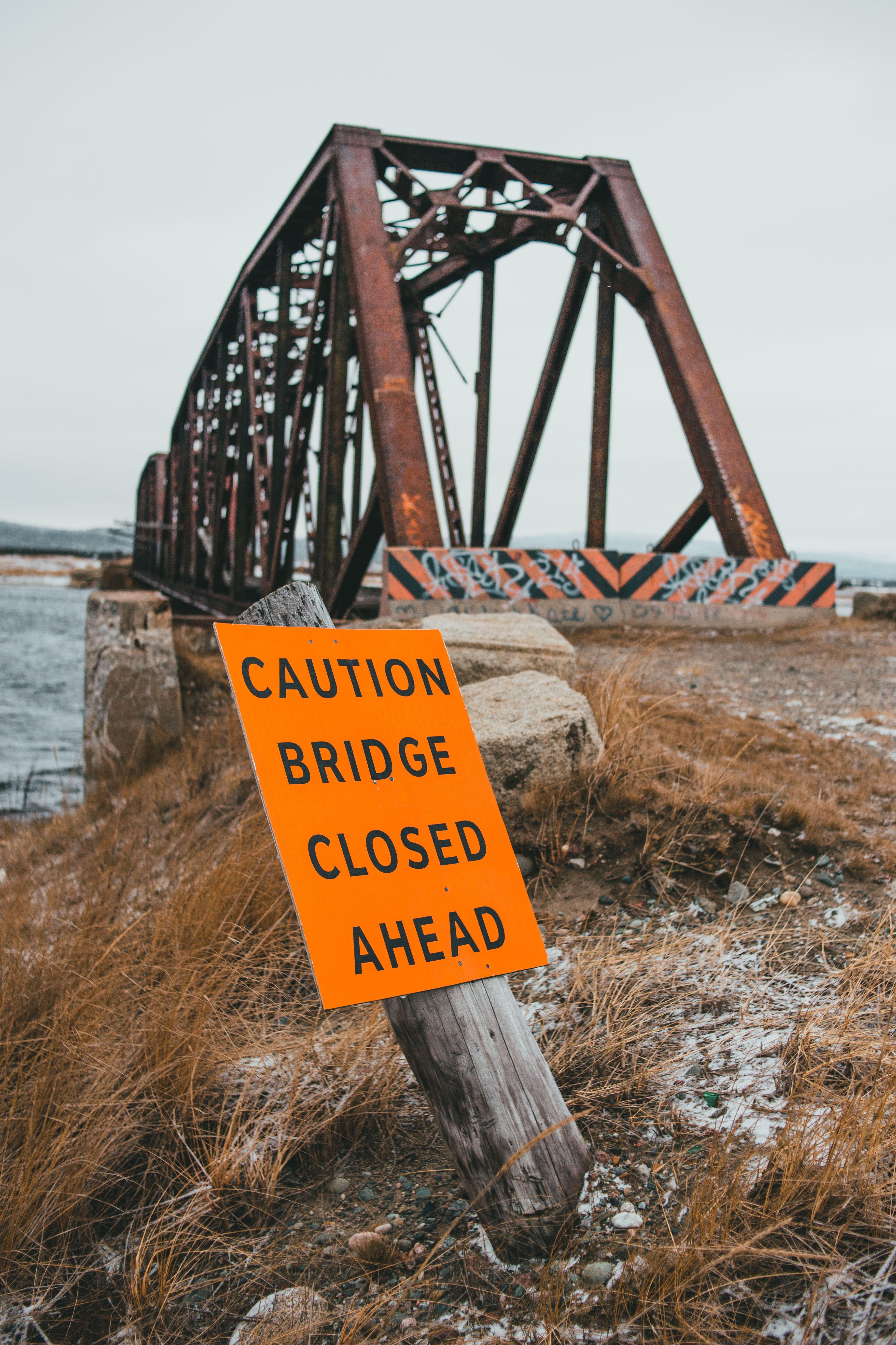 Warning sign near bridge over river · Free Stock Photo