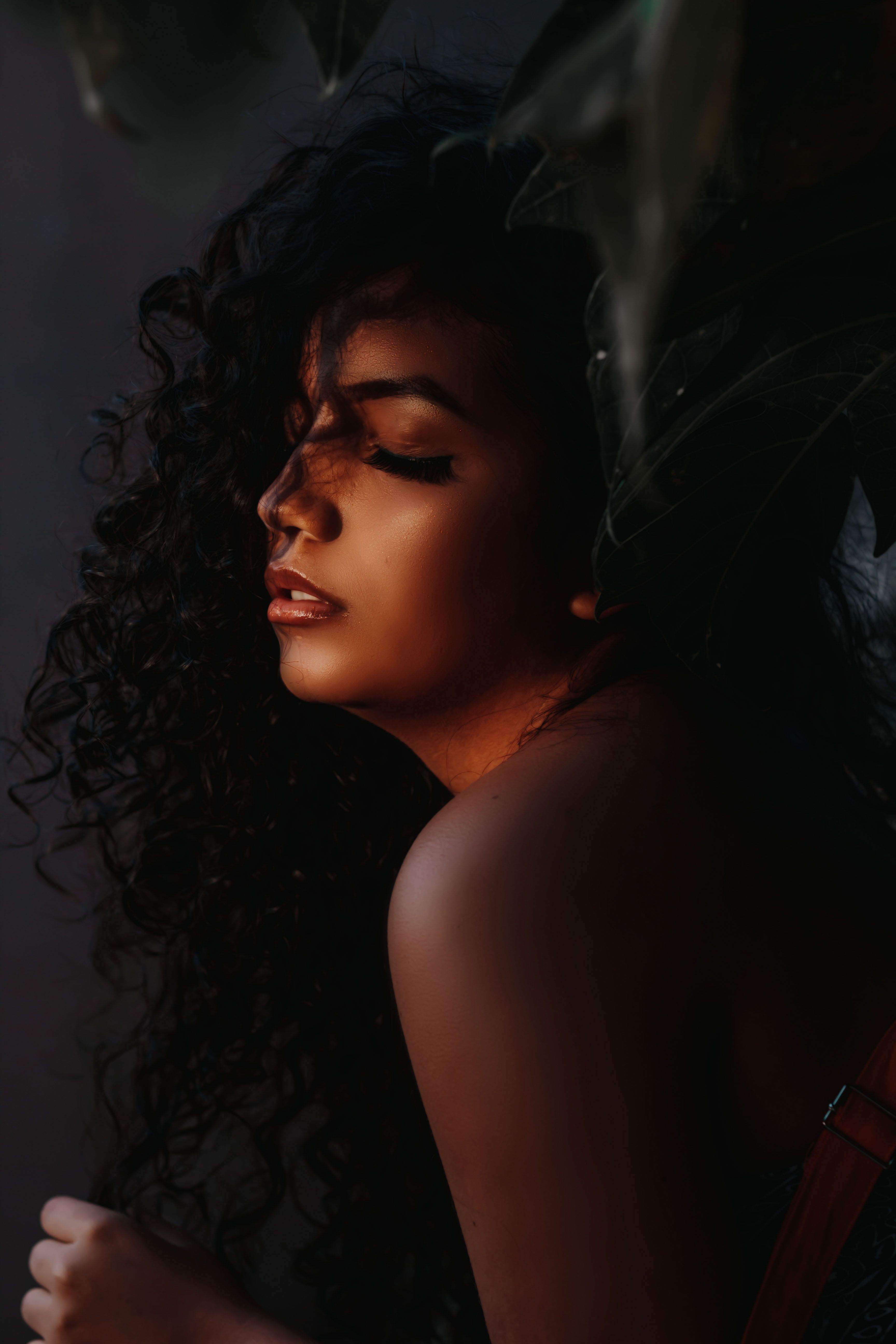 Sensual woman covering body with black bedsheet in dark studio · Free ...