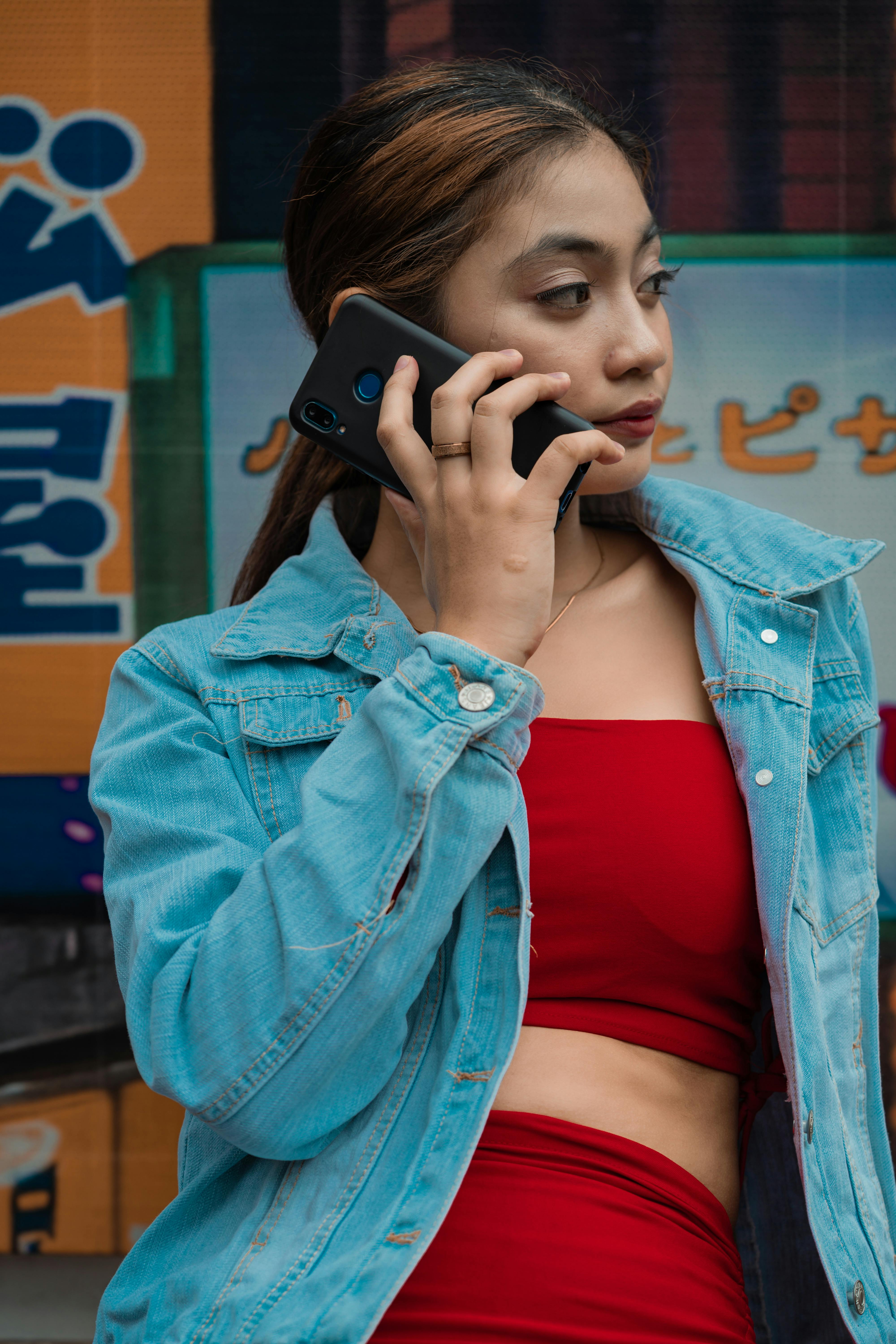 A Woman in White Shirt Calling on Her Cellphone · Free Stock Photo