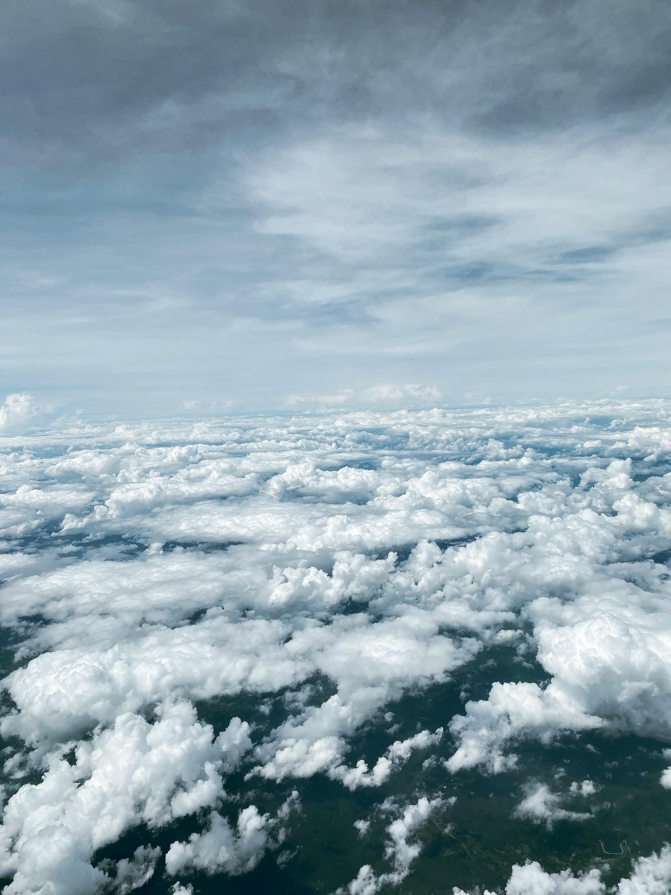 Aerial View Gray Sky Above White Clouds at Daytime · Free Stock Photo
