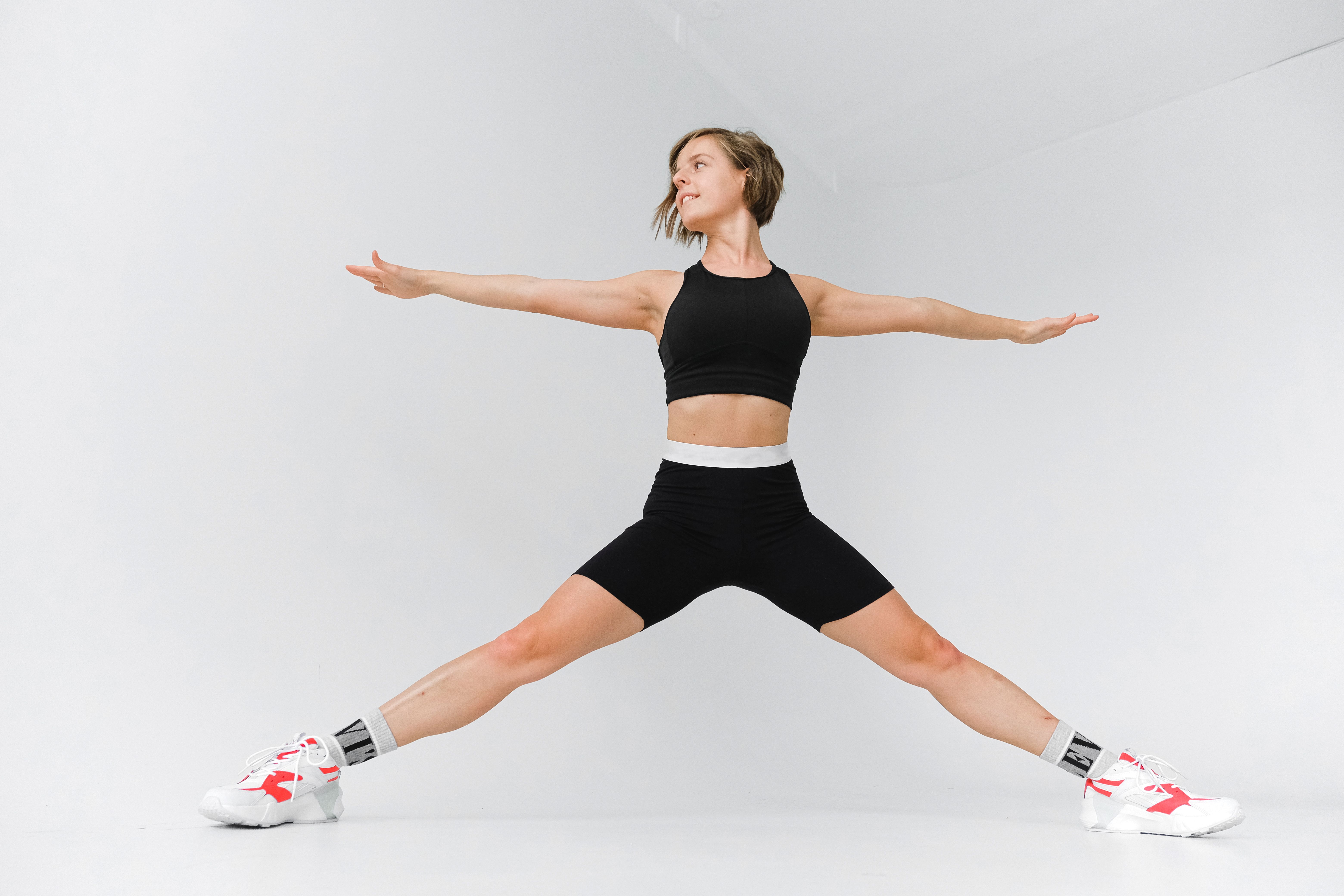 Woman with Her Arms Outstretched and Legs Crossed · Free Stock Photo
