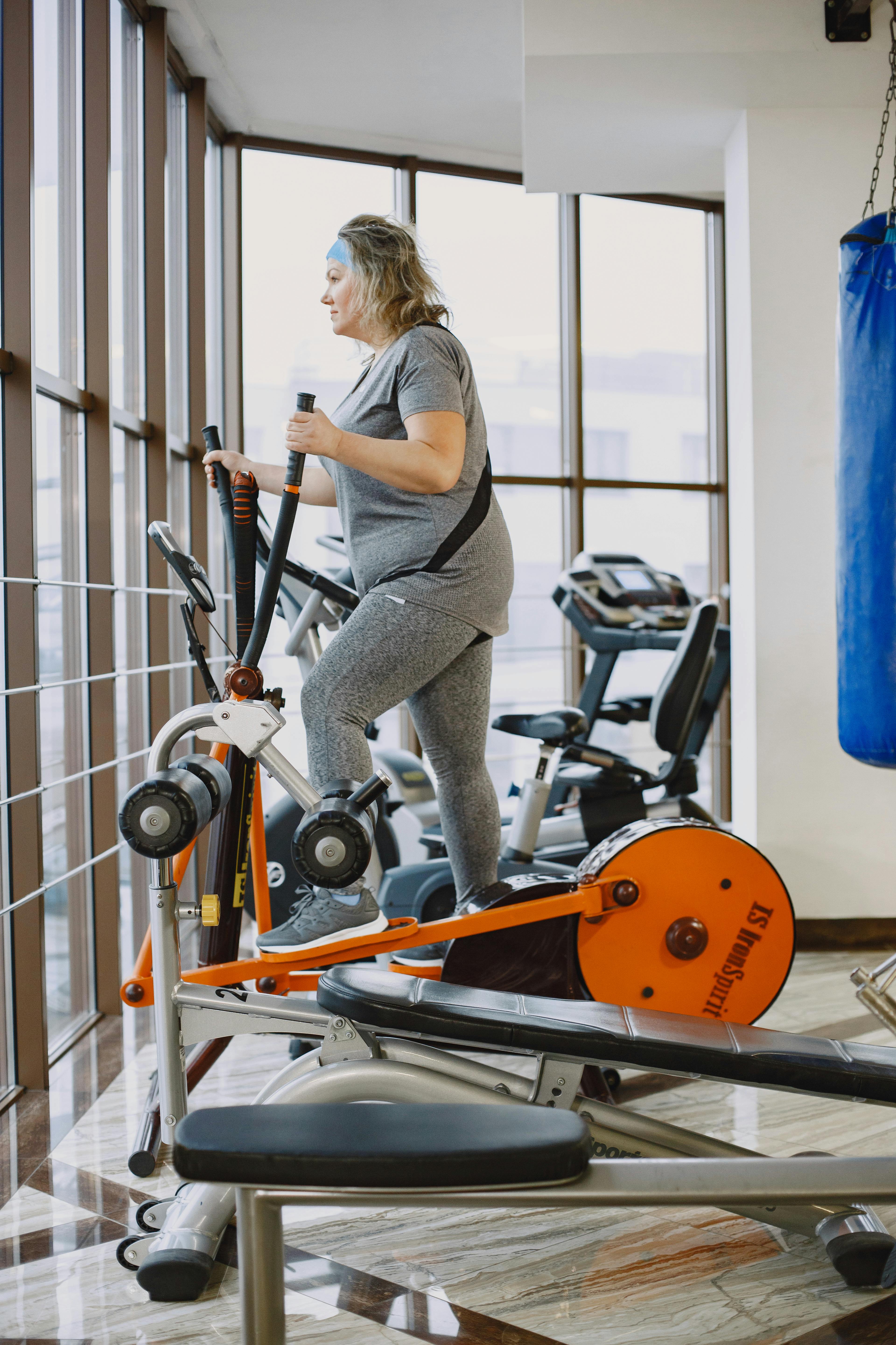 Woman on Elliptical Trainer · Free Stock Photo