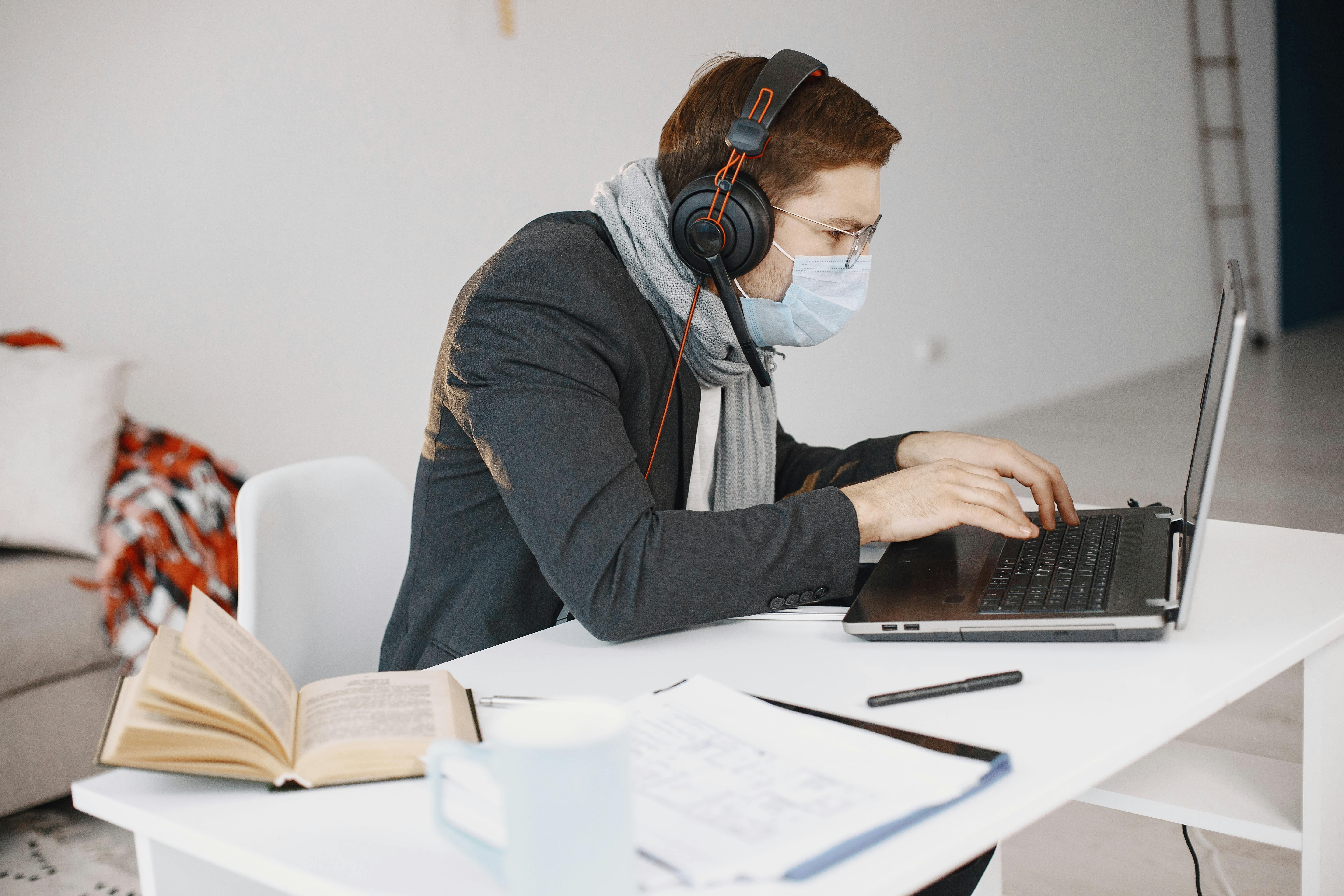 A Man in Black Suit Using a Laptop · Free Stock Photo