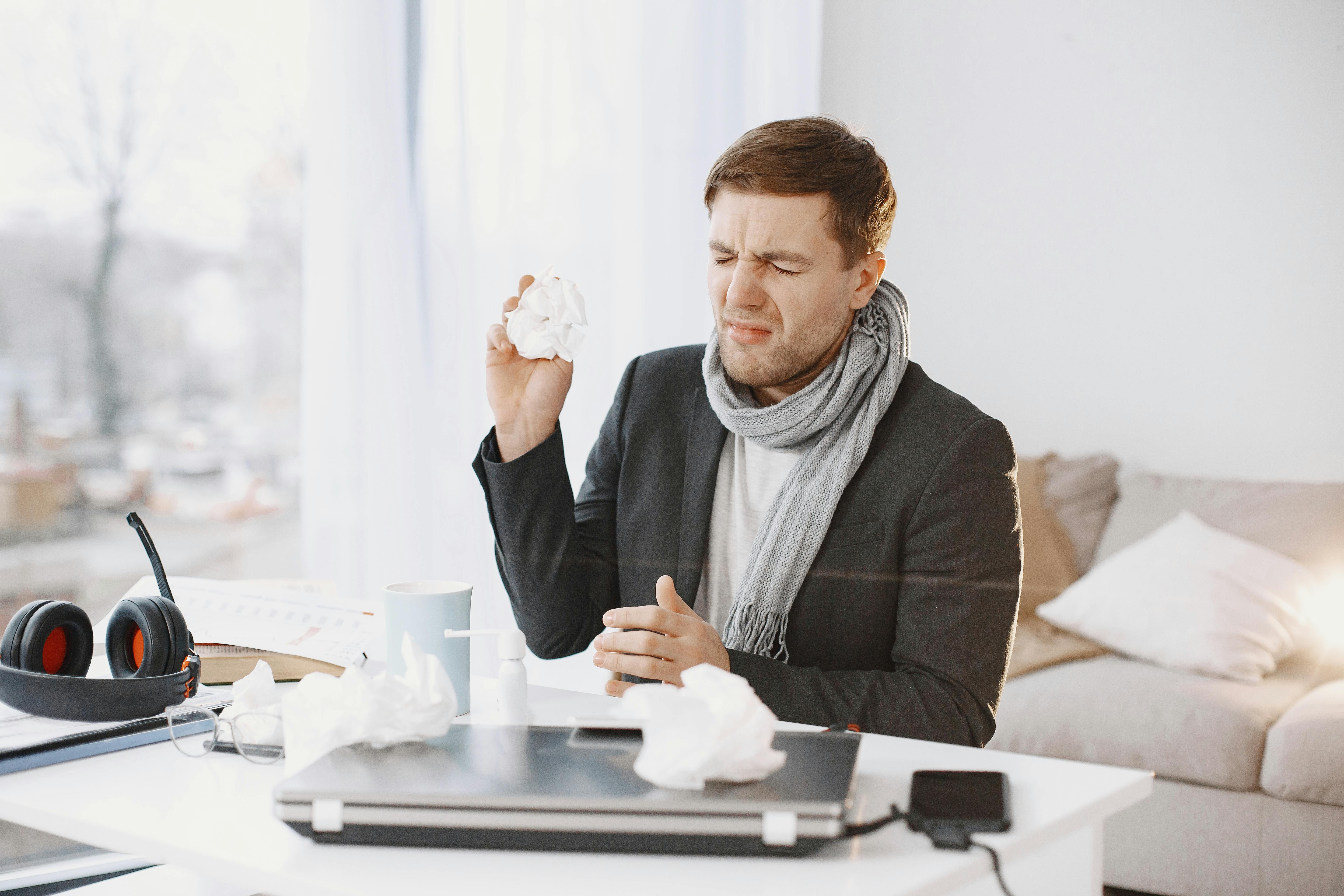 Man with Cold Sitting at Desk · Free Stock Photo
