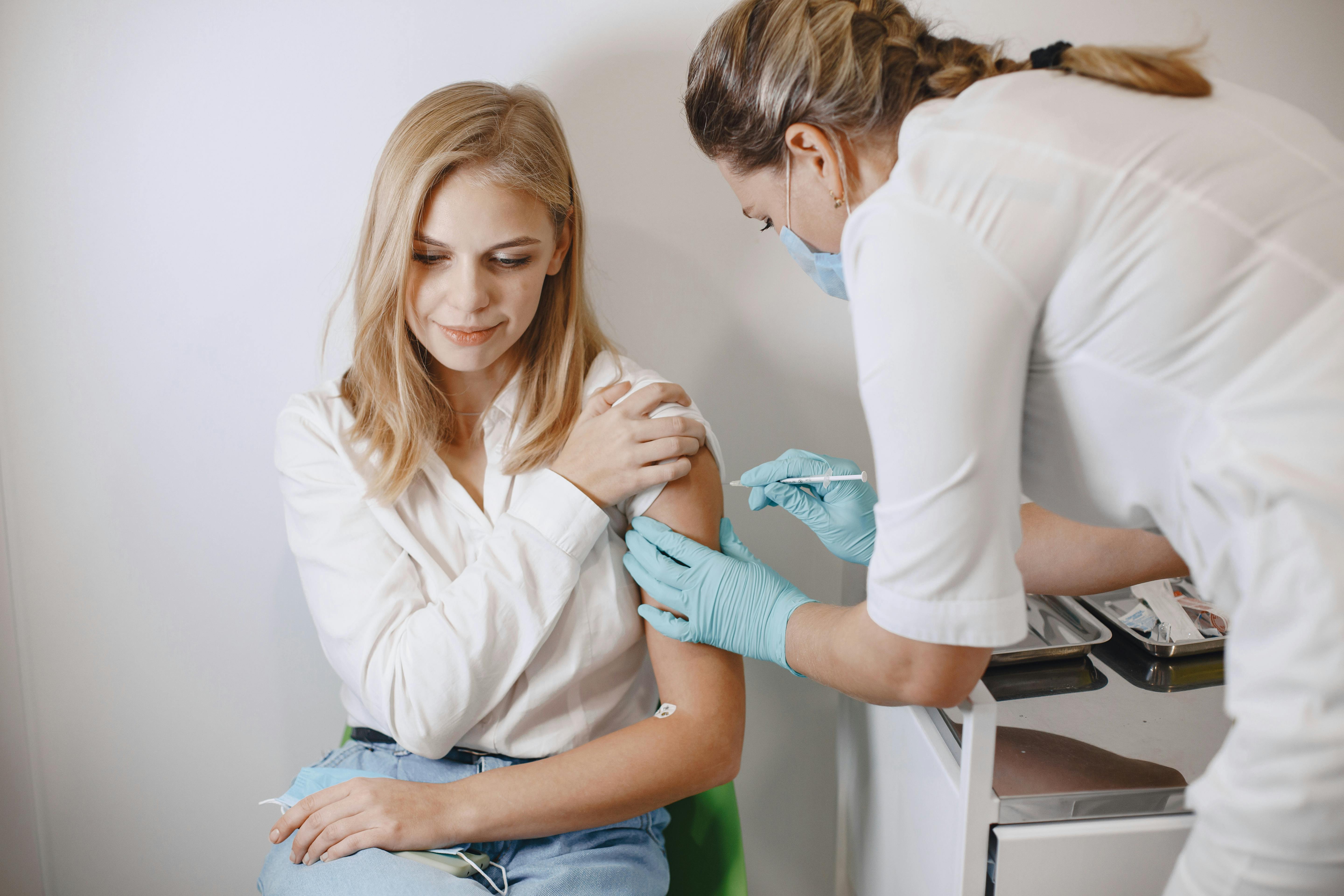 A Woman Getting an Injection · Free Stock Photo