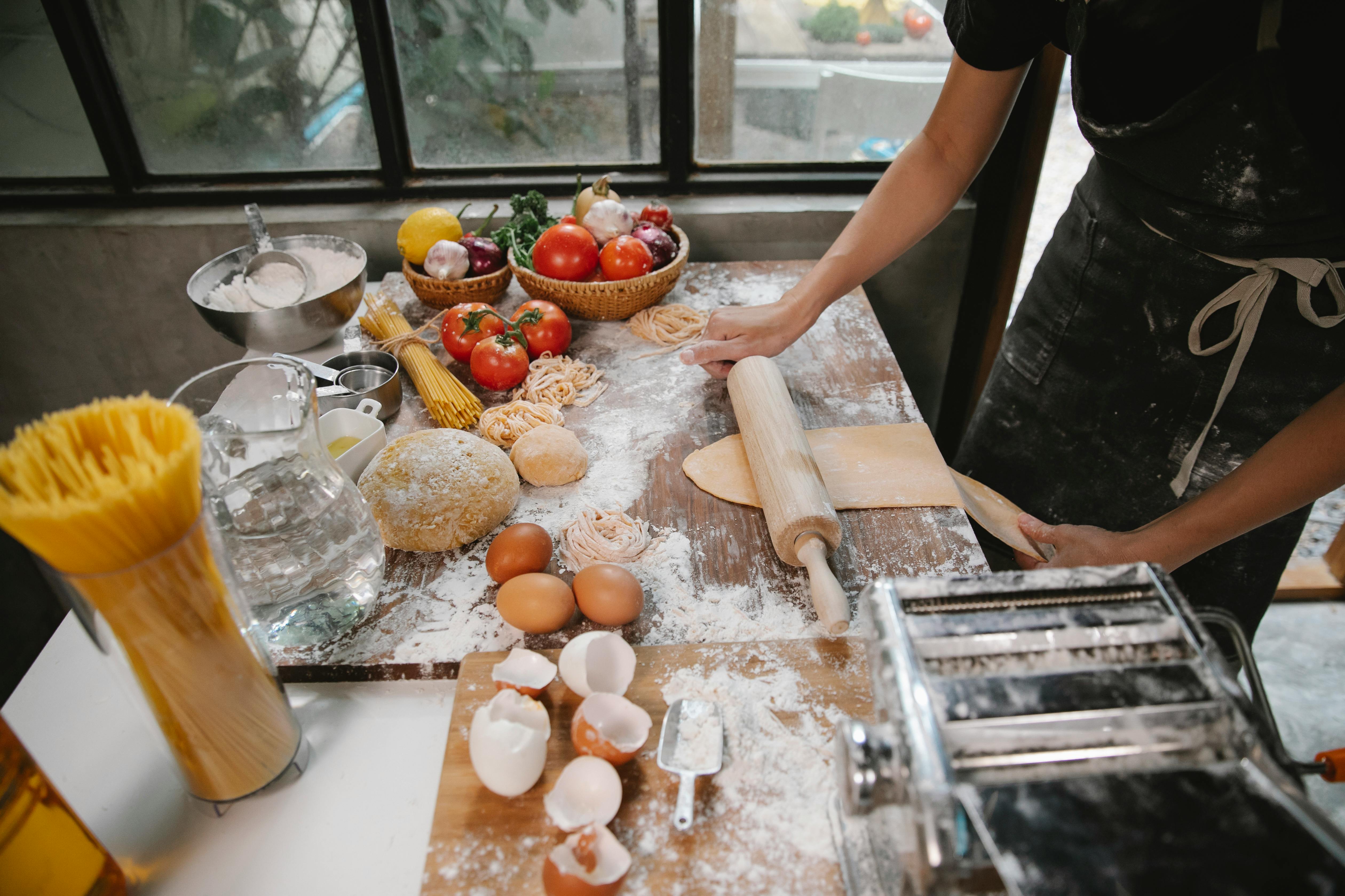 Person Rolling Dough with Flour and Rolling Pin · Free Stock Photo