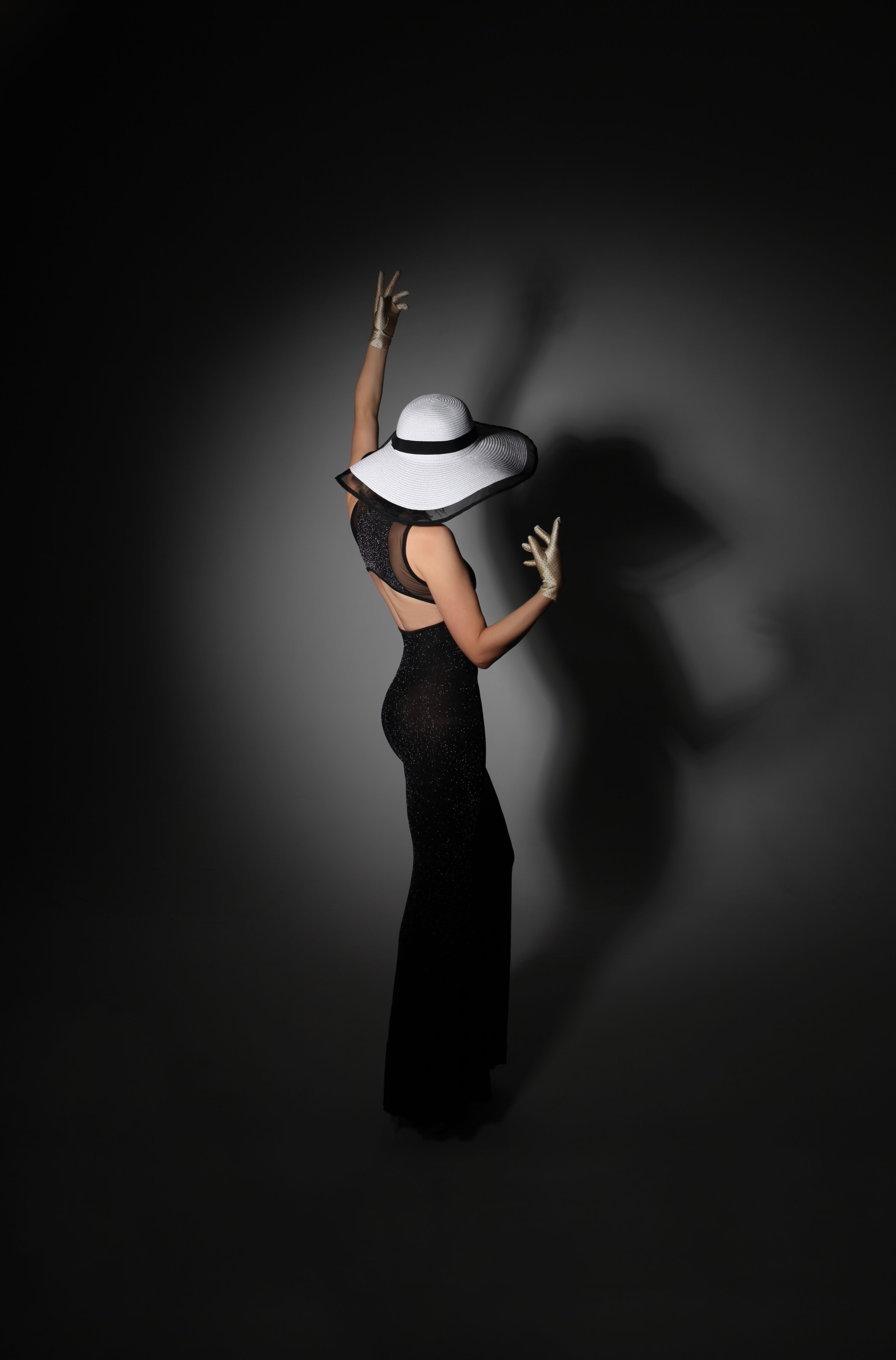 Anonymous woman in hat standing near wall · Free Stock Photo