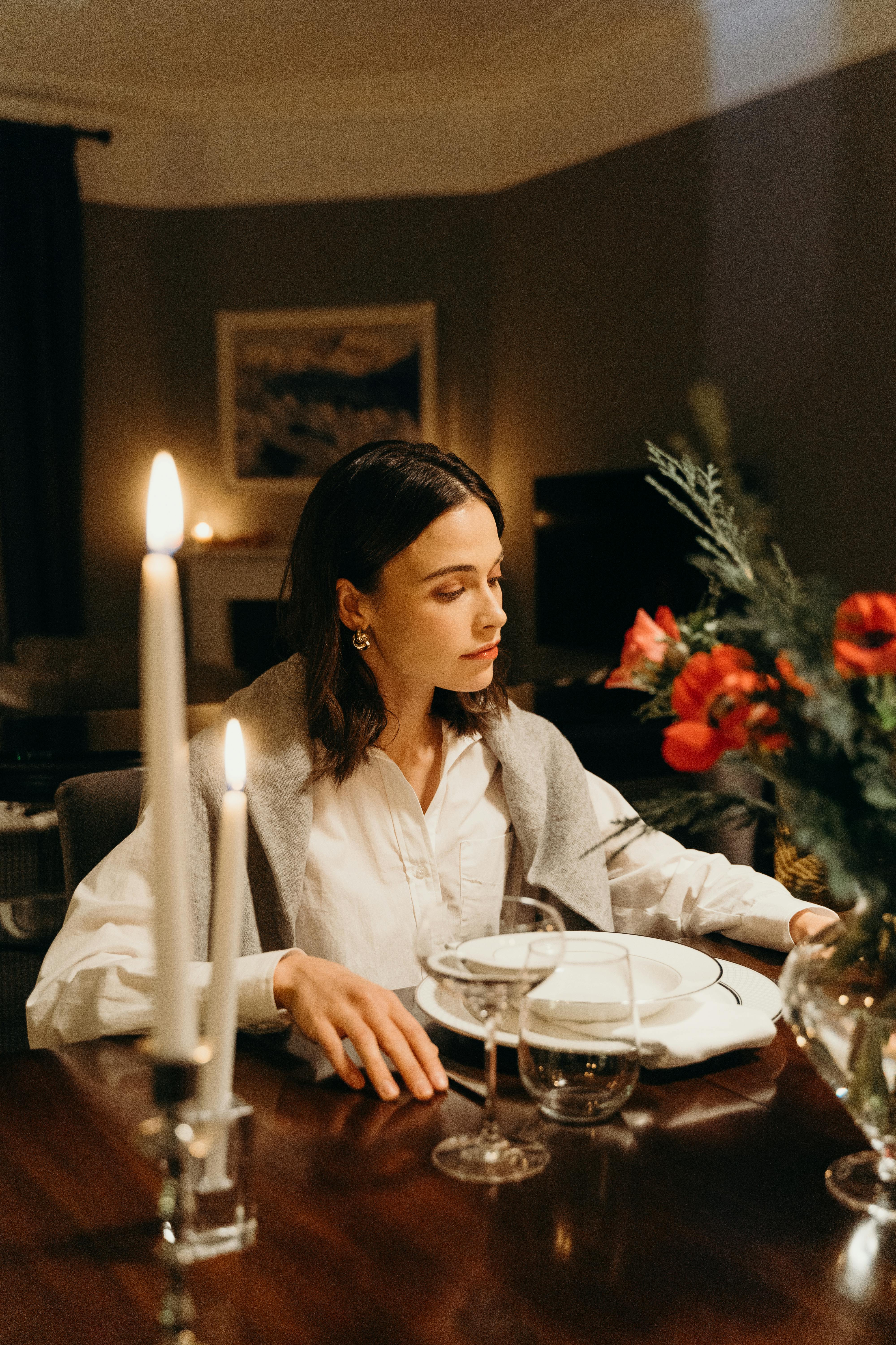 An Elegant Woman Having Dinner by Candlelight · Free Stock Photo