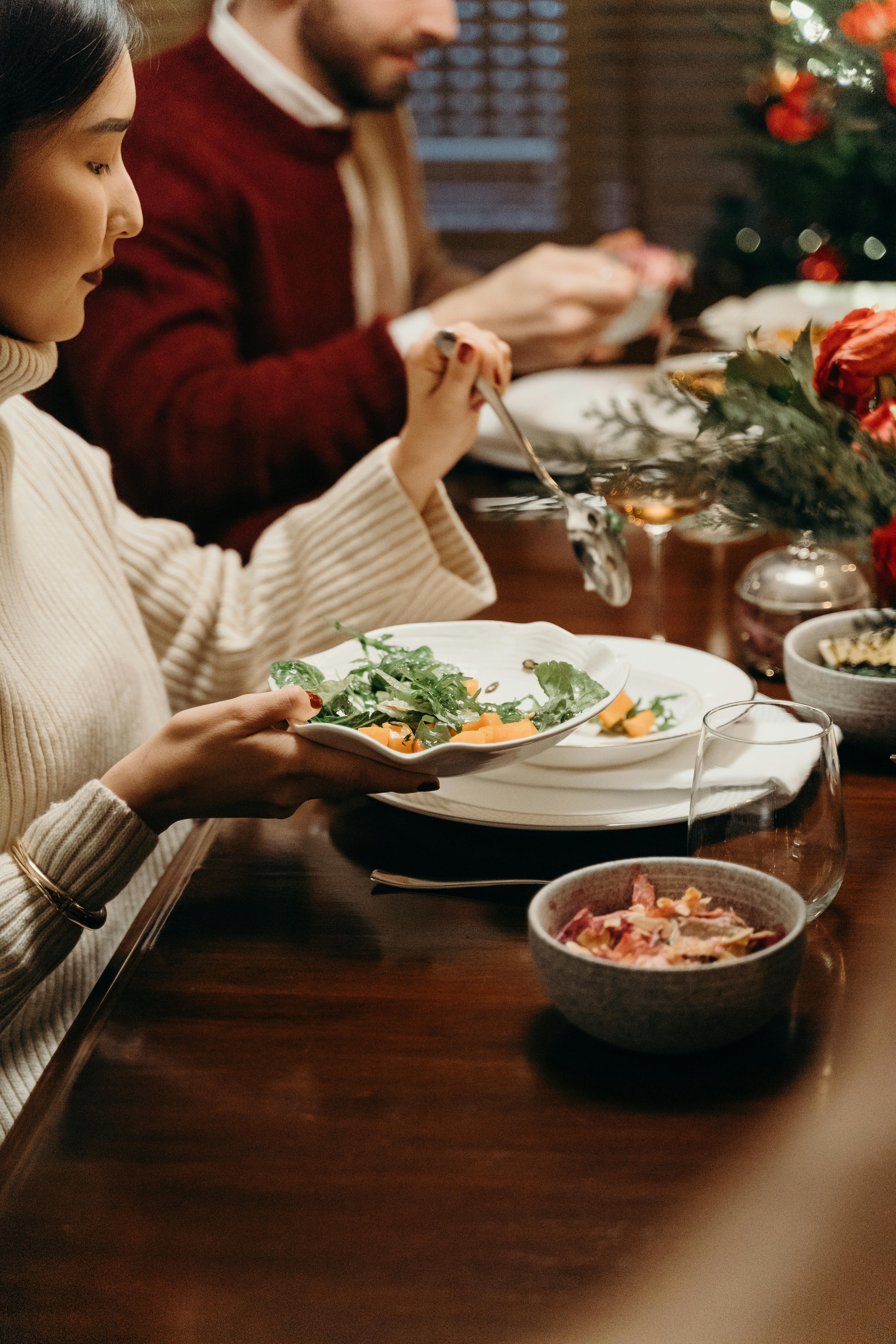 A Woman Putting Food on her Plate · Free Stock Photo