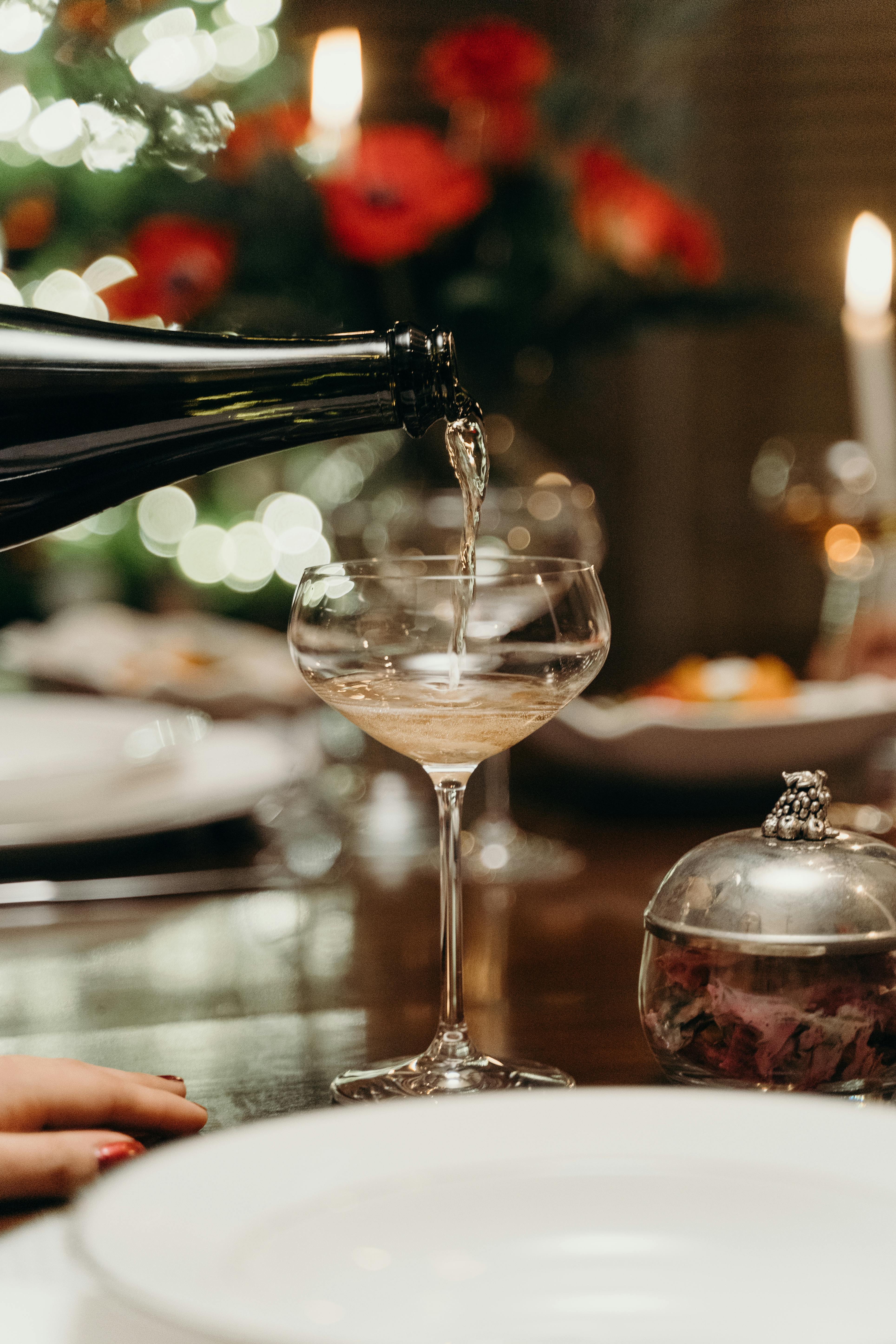 Glass of red wine served on wooden table decorated with flowers · Free ...