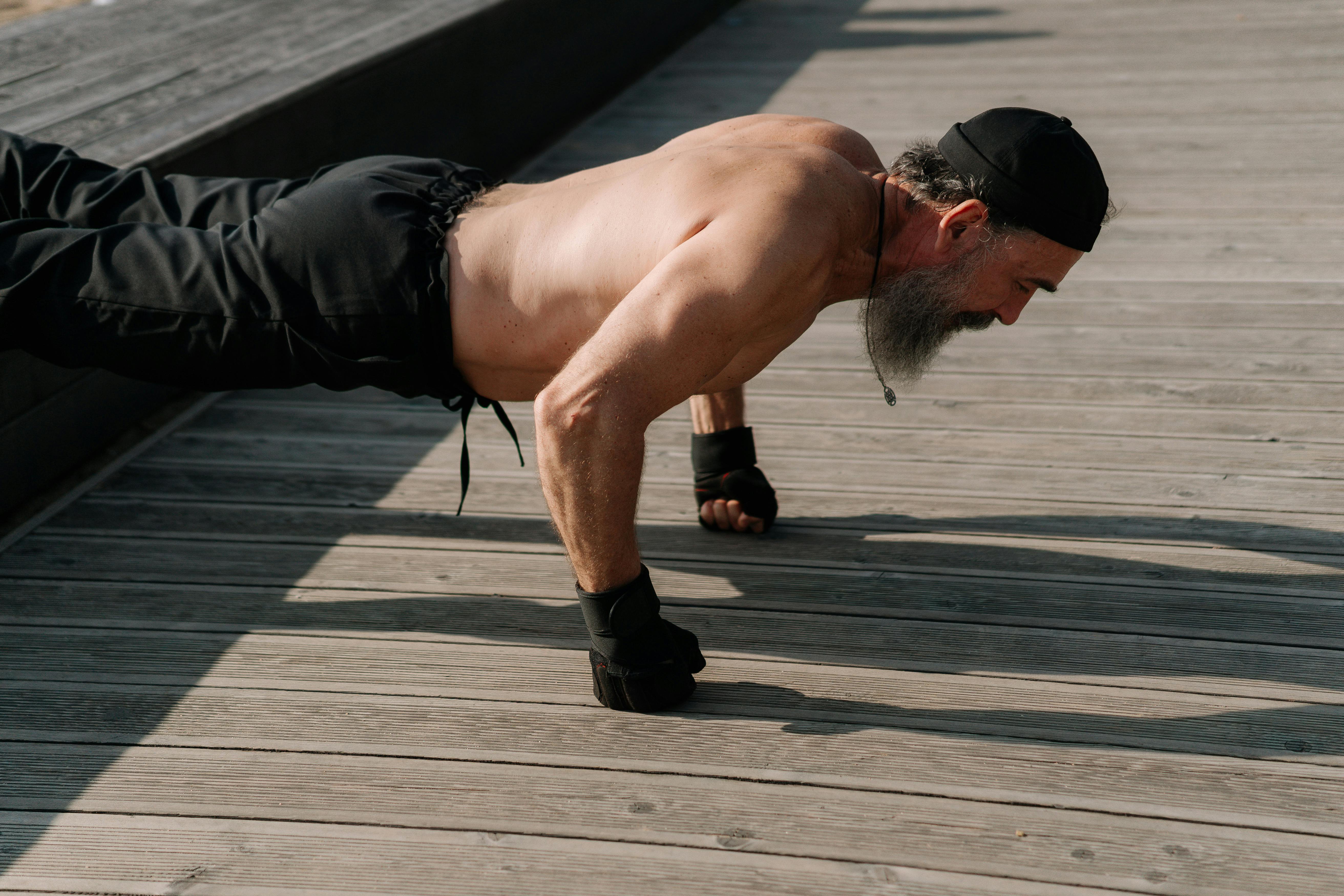 A Man Working Out on the Wooden Floor · Free Stock Photo