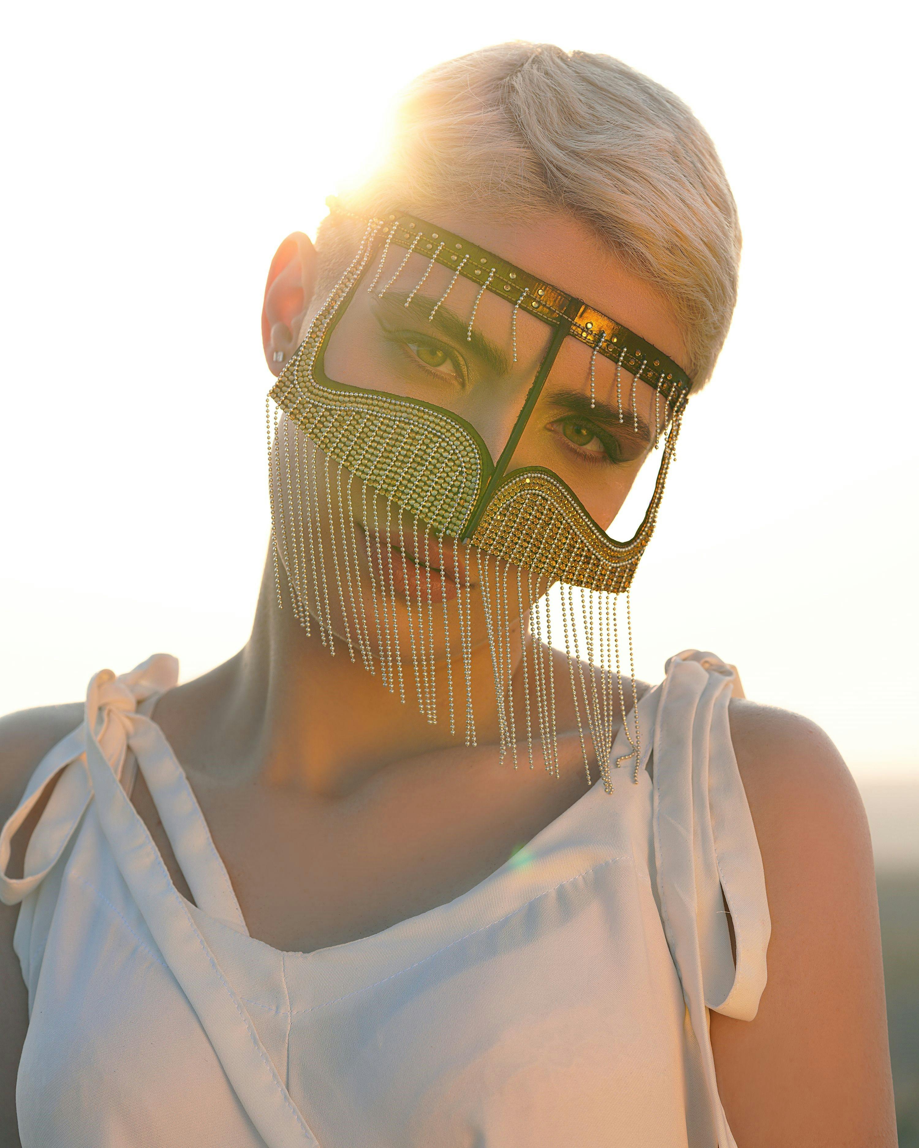 A Woman Wearing a Gold Mask · Free Stock Photo
