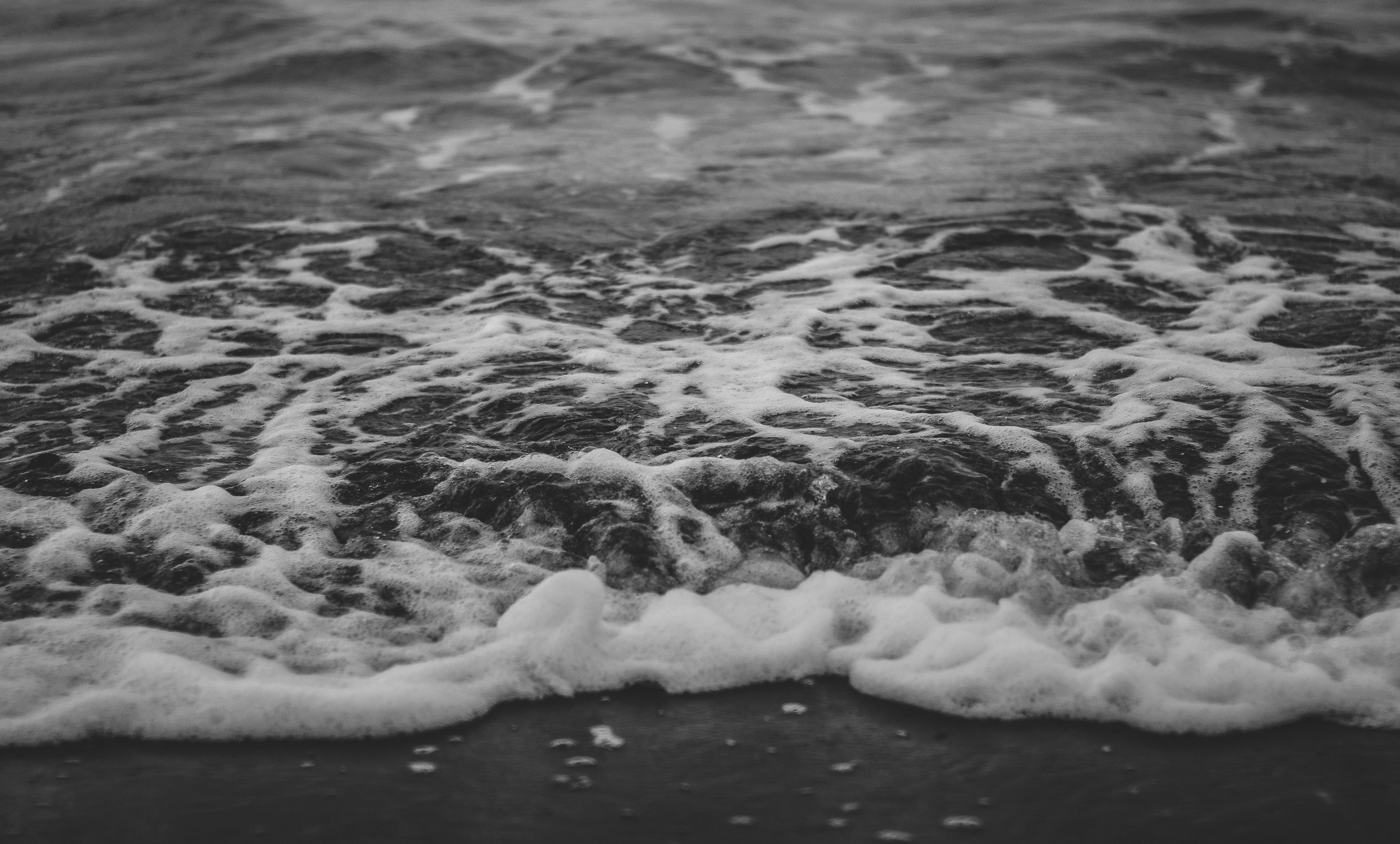Grayscale Photography of Sea Waves Lapping on Shore · Free Stock Photo