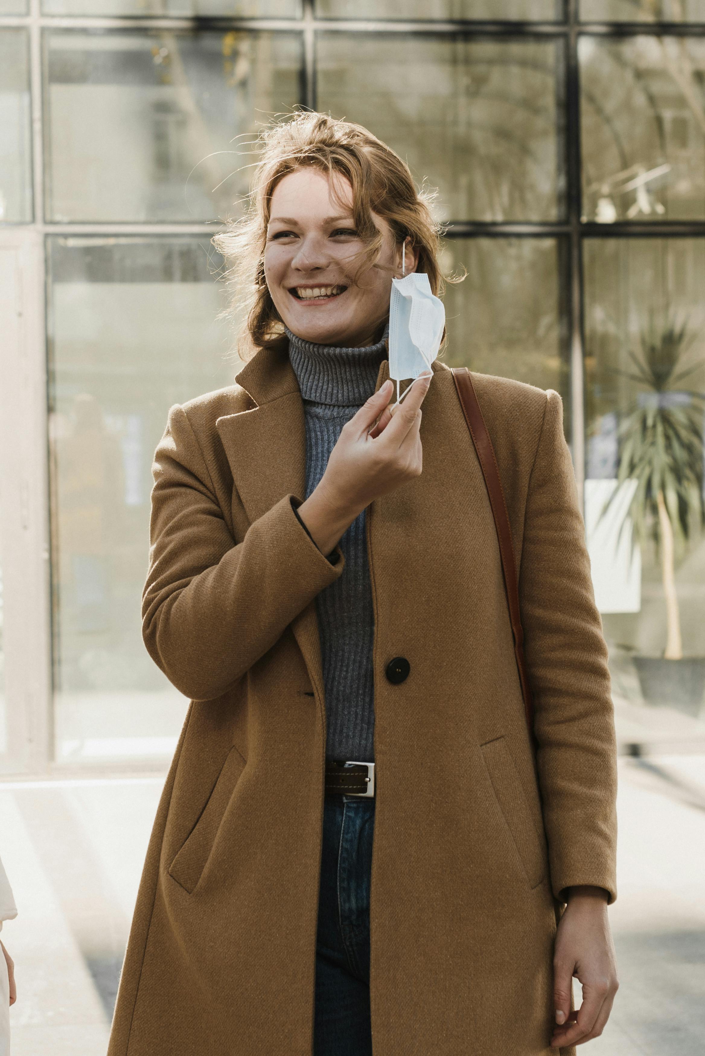 A Woman Removing Her Face Mask · Free Stock Photo