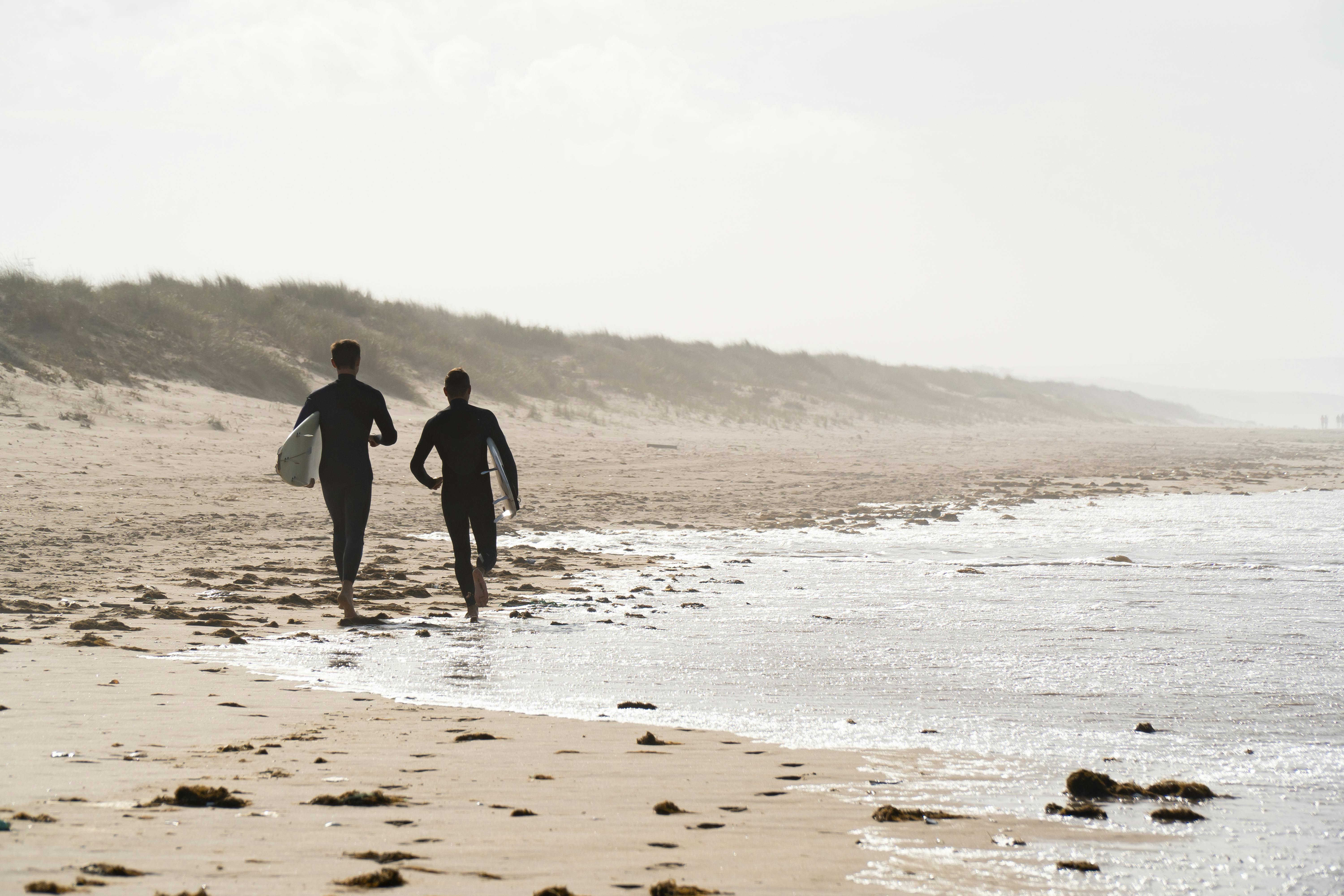 Men With Surfboards Running on the Beach · Free Stock Photo