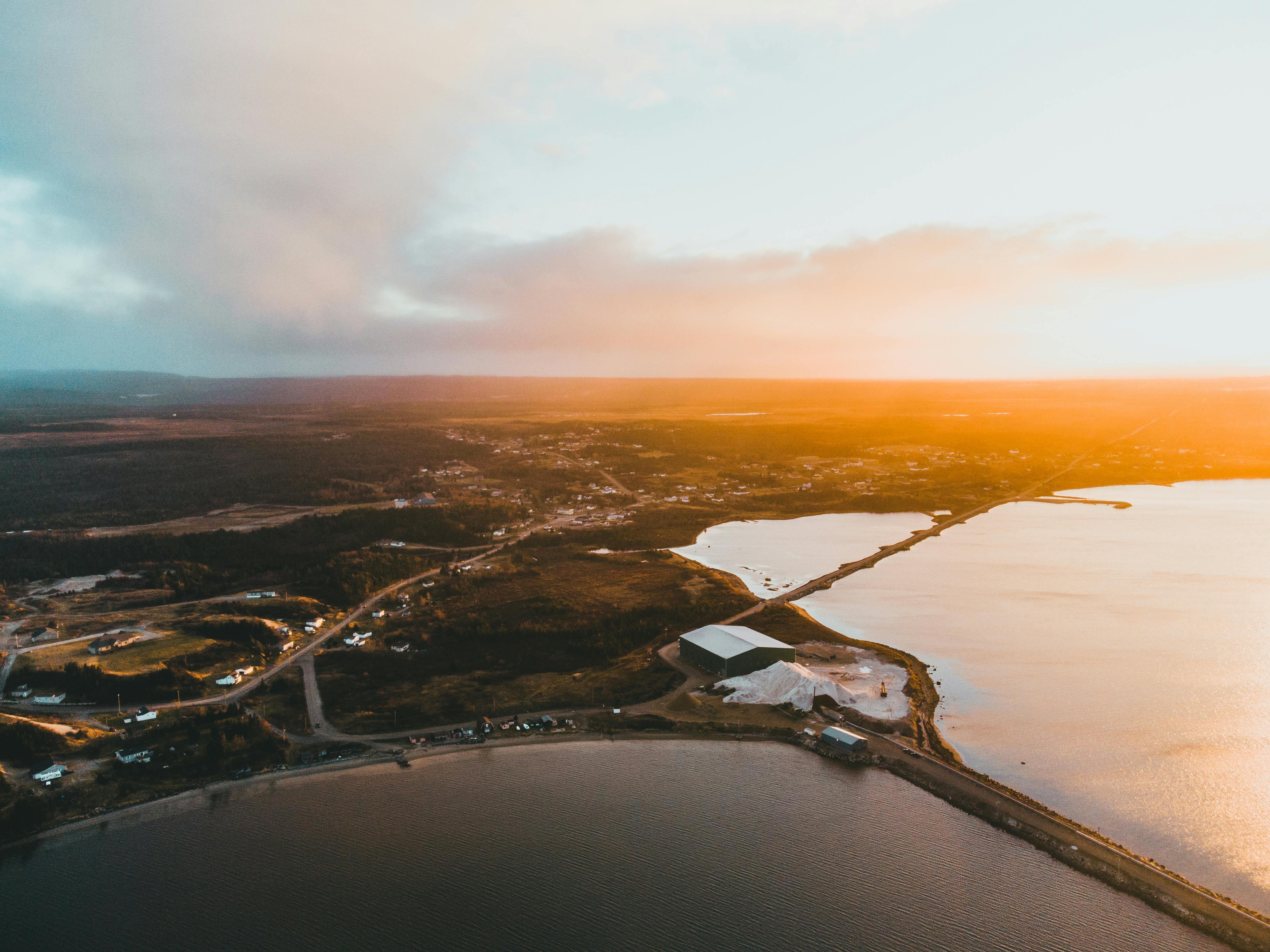 Cityscape of town with river at sunset · Free Stock Photo