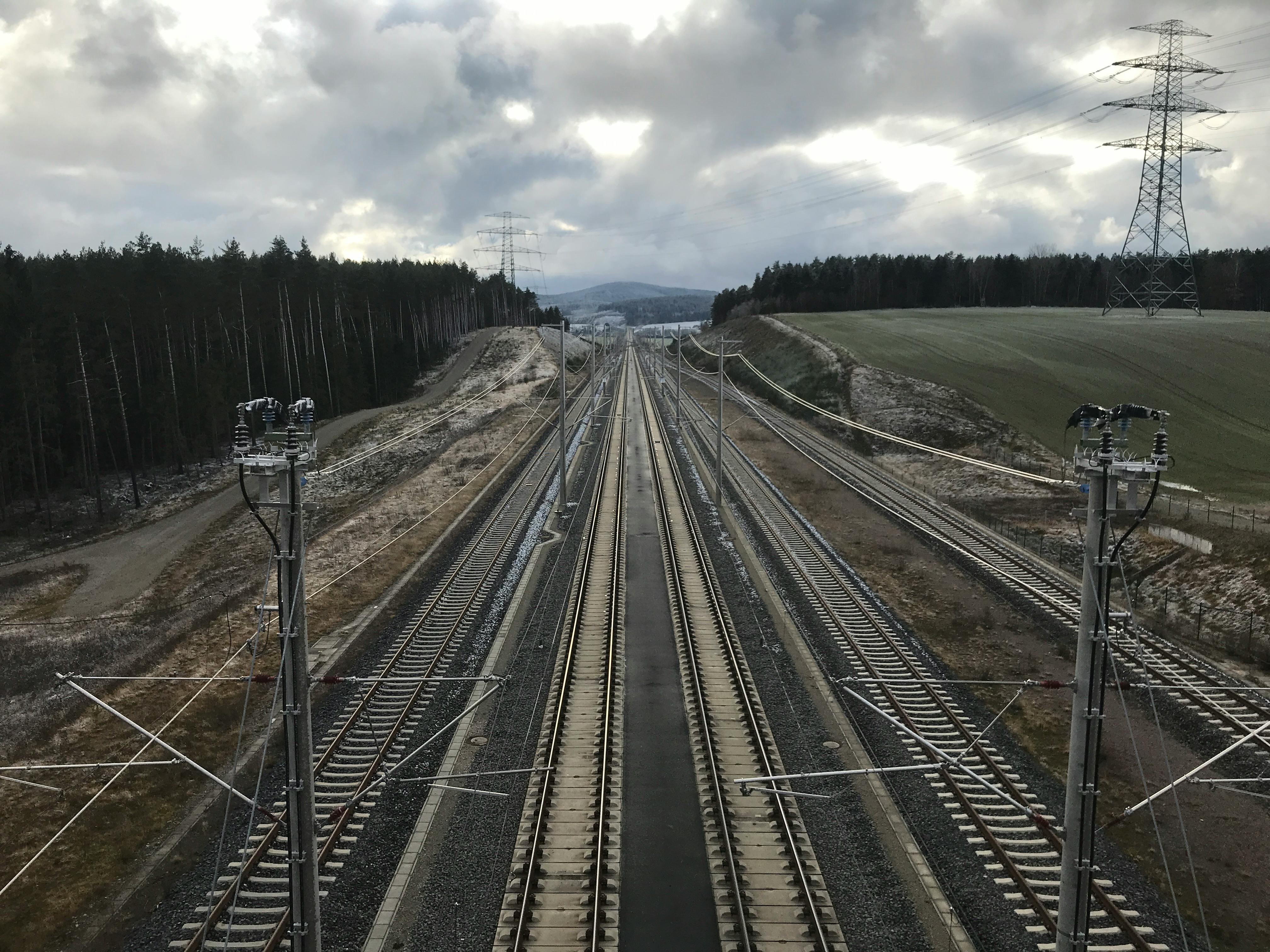 A Railway Between Green Trees · Free Stock Photo