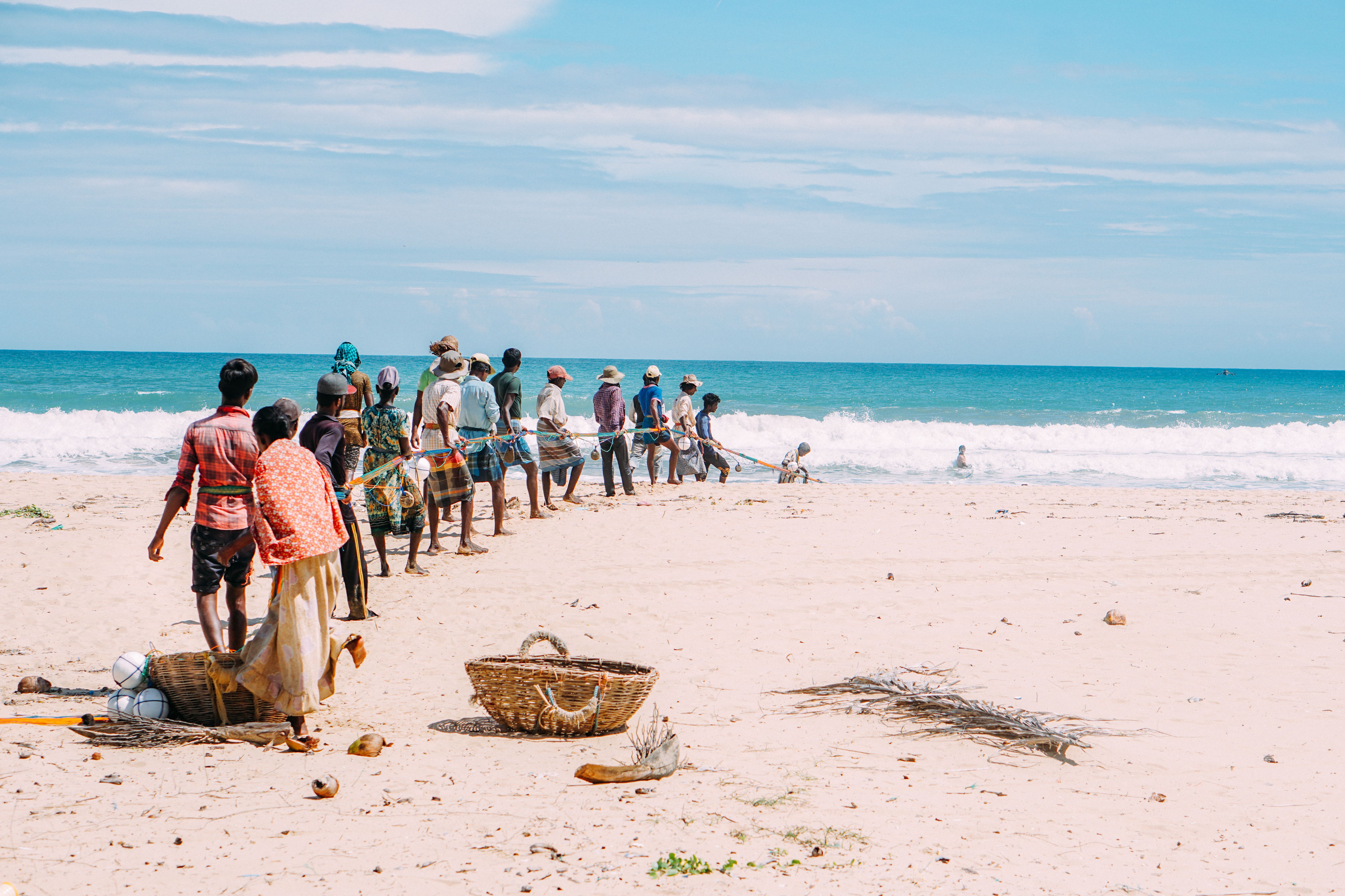A Line of People on a Beach · Free Stock Photo