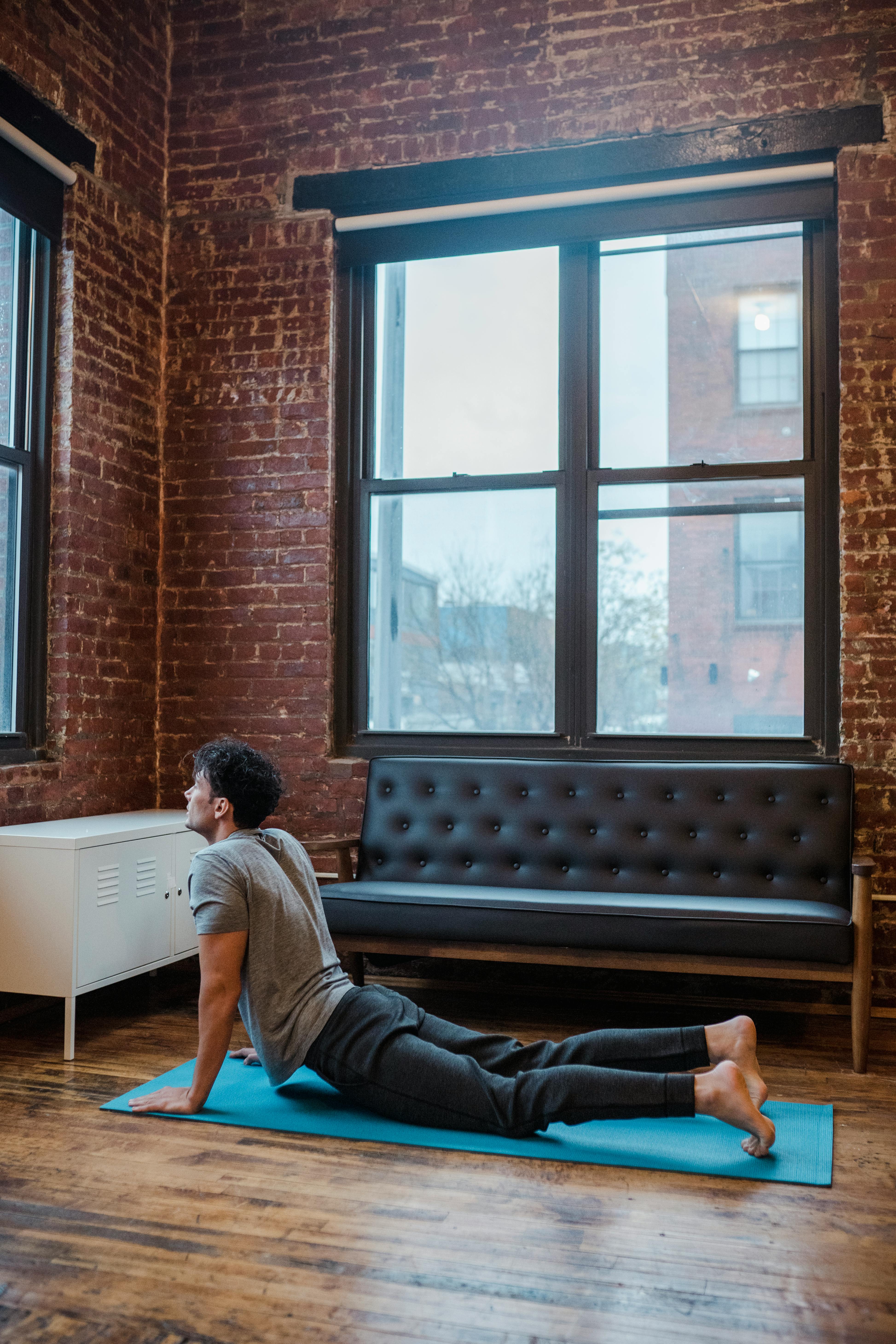 Man practicing meditation in High Cobra position · Free Stock Photo