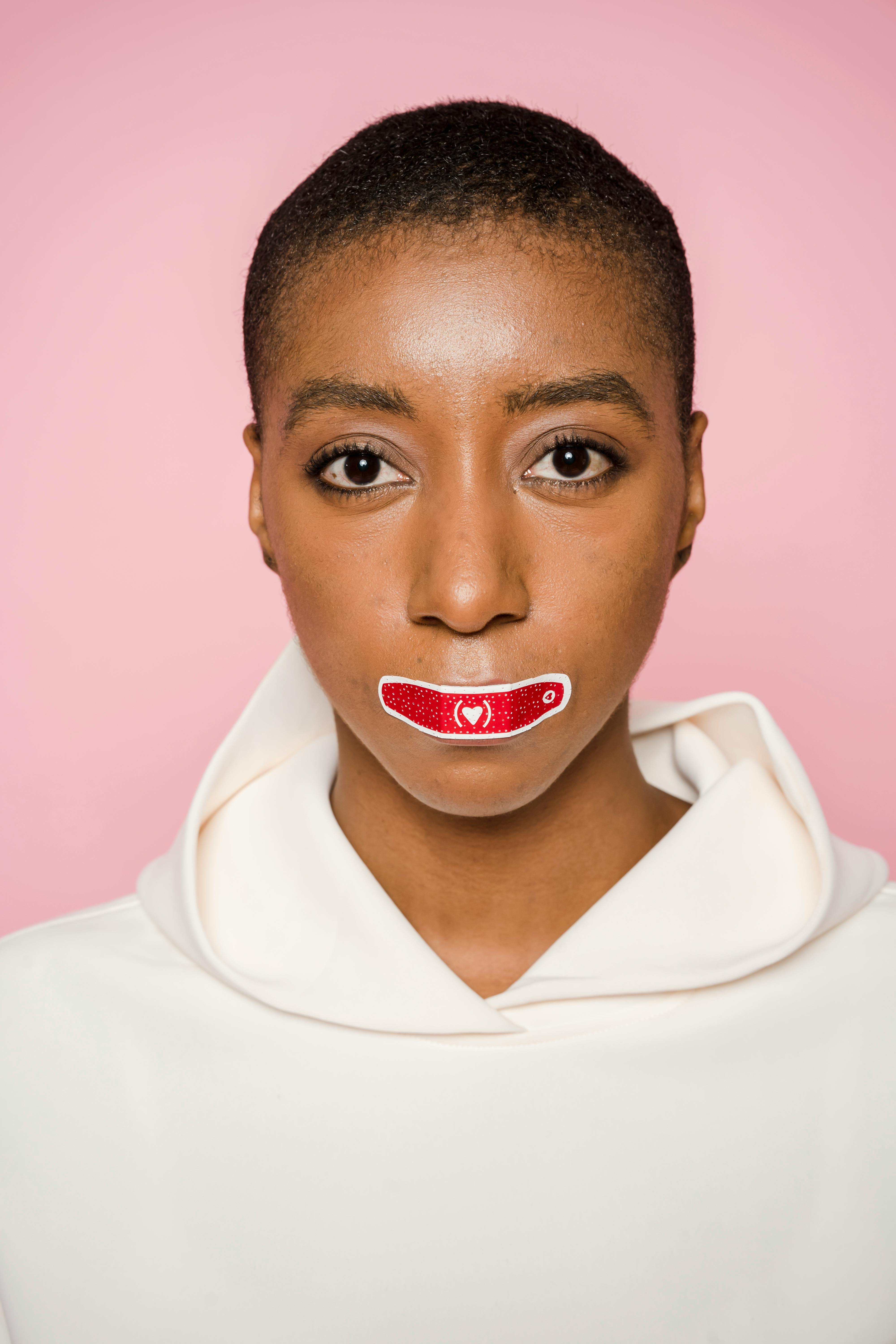 Photo Of A Woman With Lips Covered With Band Aid · Free Stock Photo