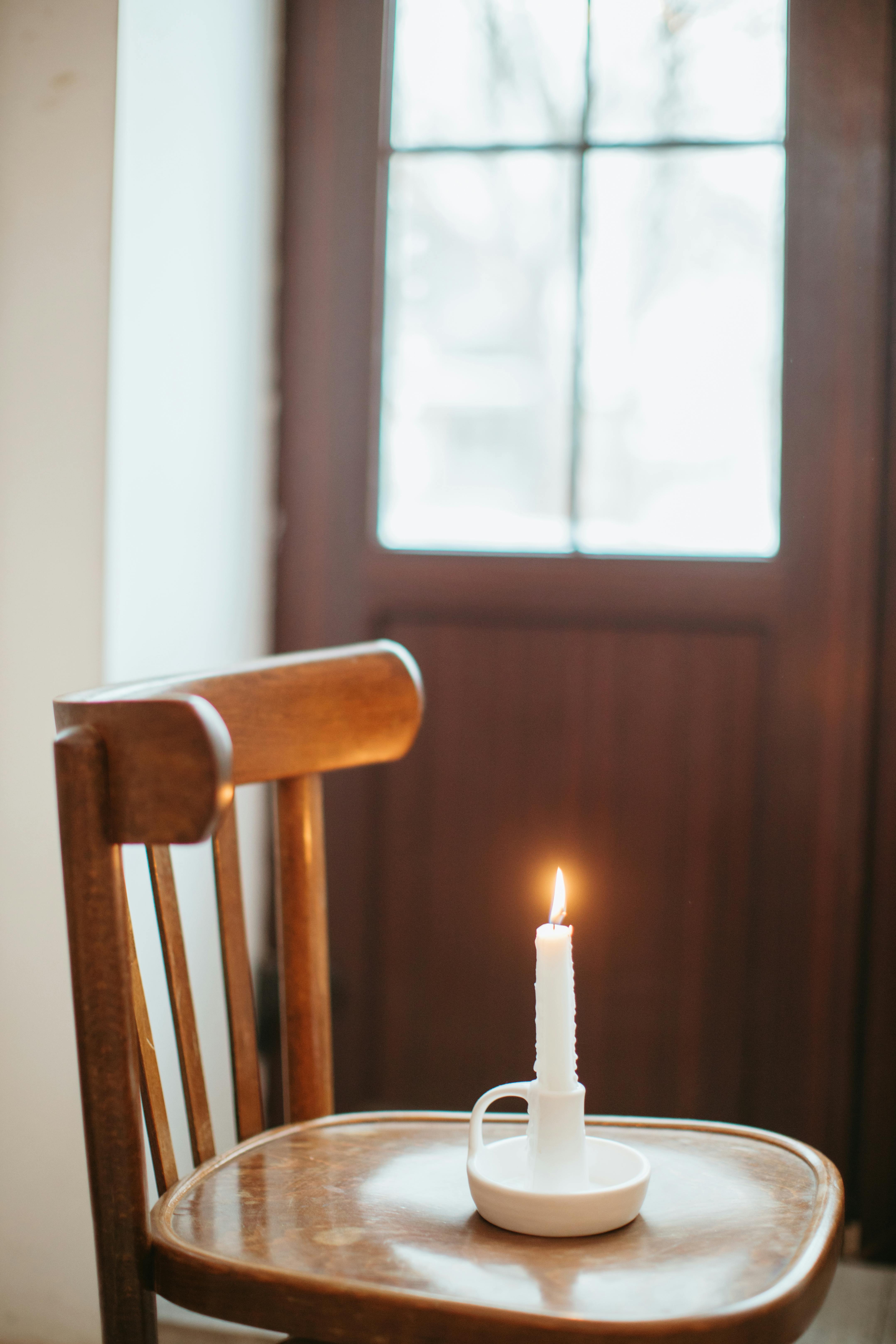 Lighted Candle on Wooden Chair · Free Stock Photo