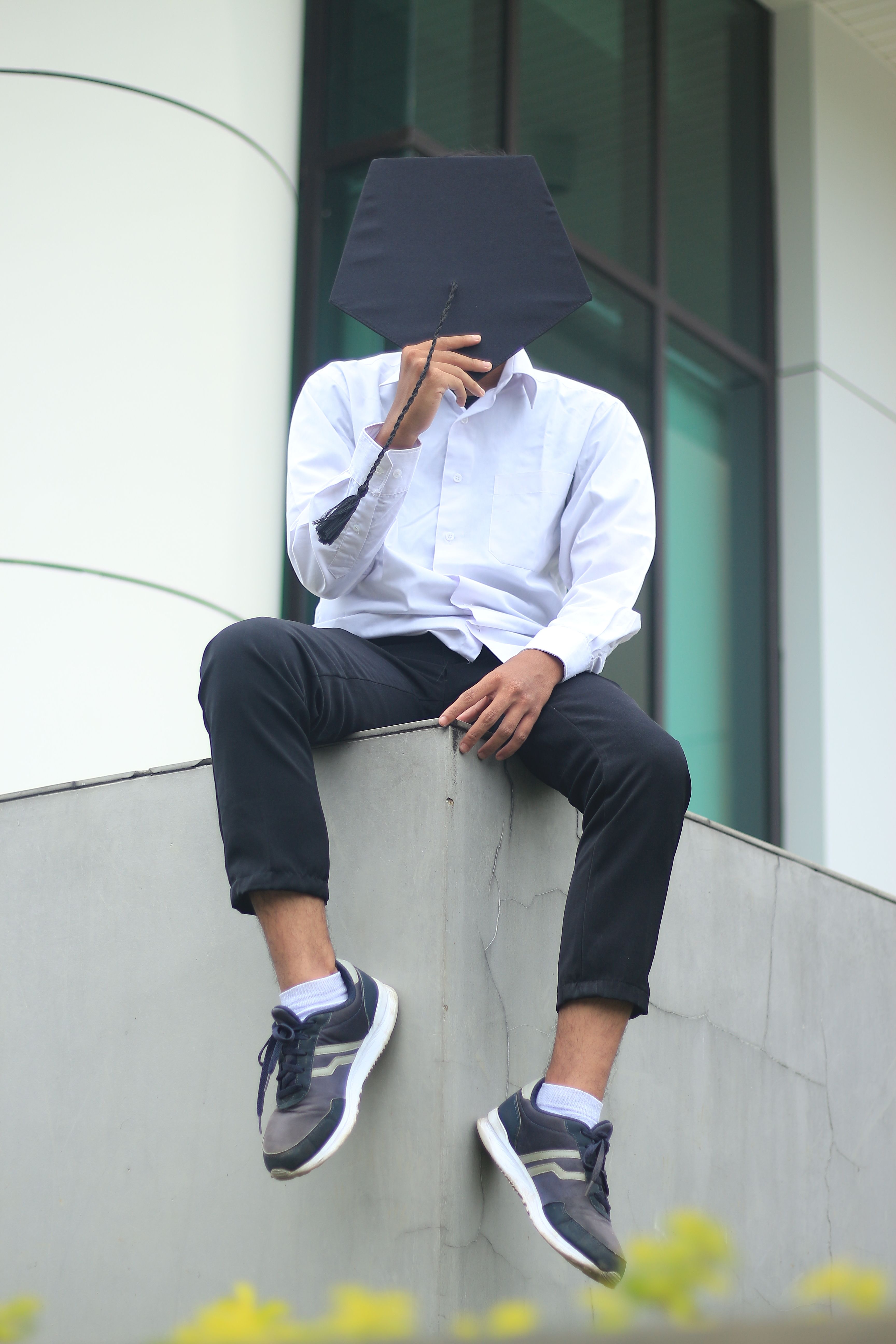 Man Covering His Face with the Graduation Hat · Free Stock Photo