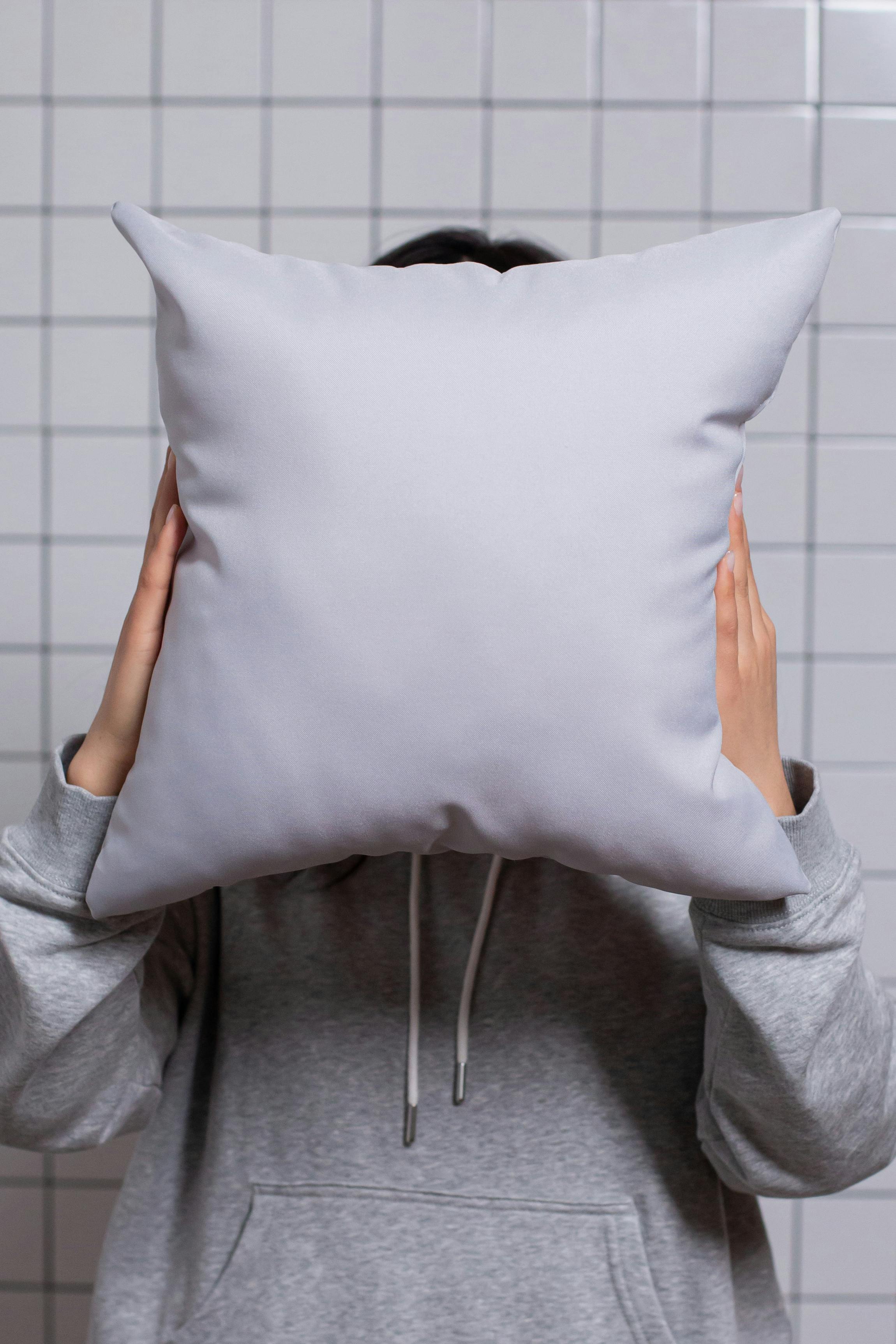 Close-Up Shot of a Person Holding a Pillow · Free Stock Photo
