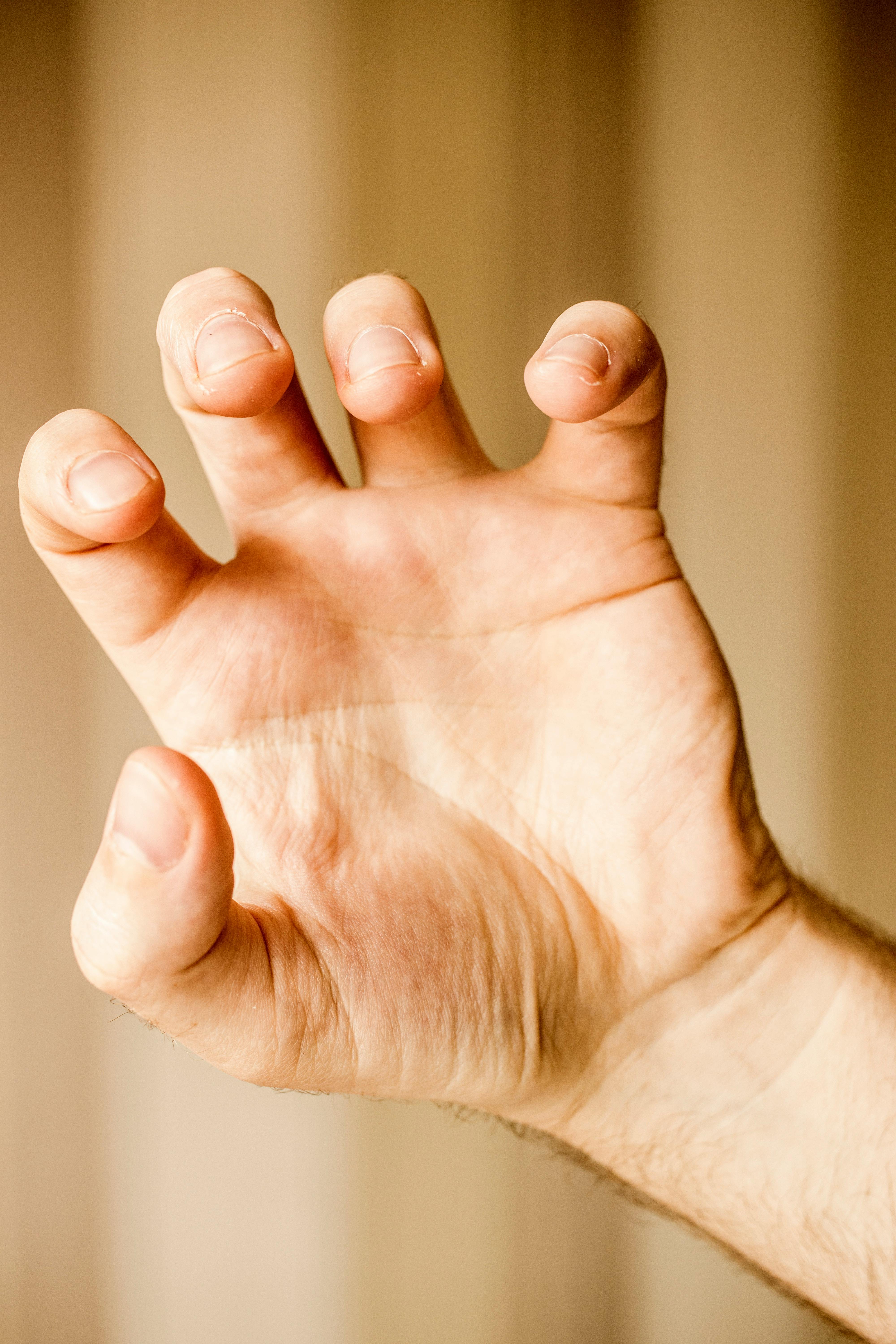 Close-Up View of a Person Clenching His Hands · Free Stock Photo