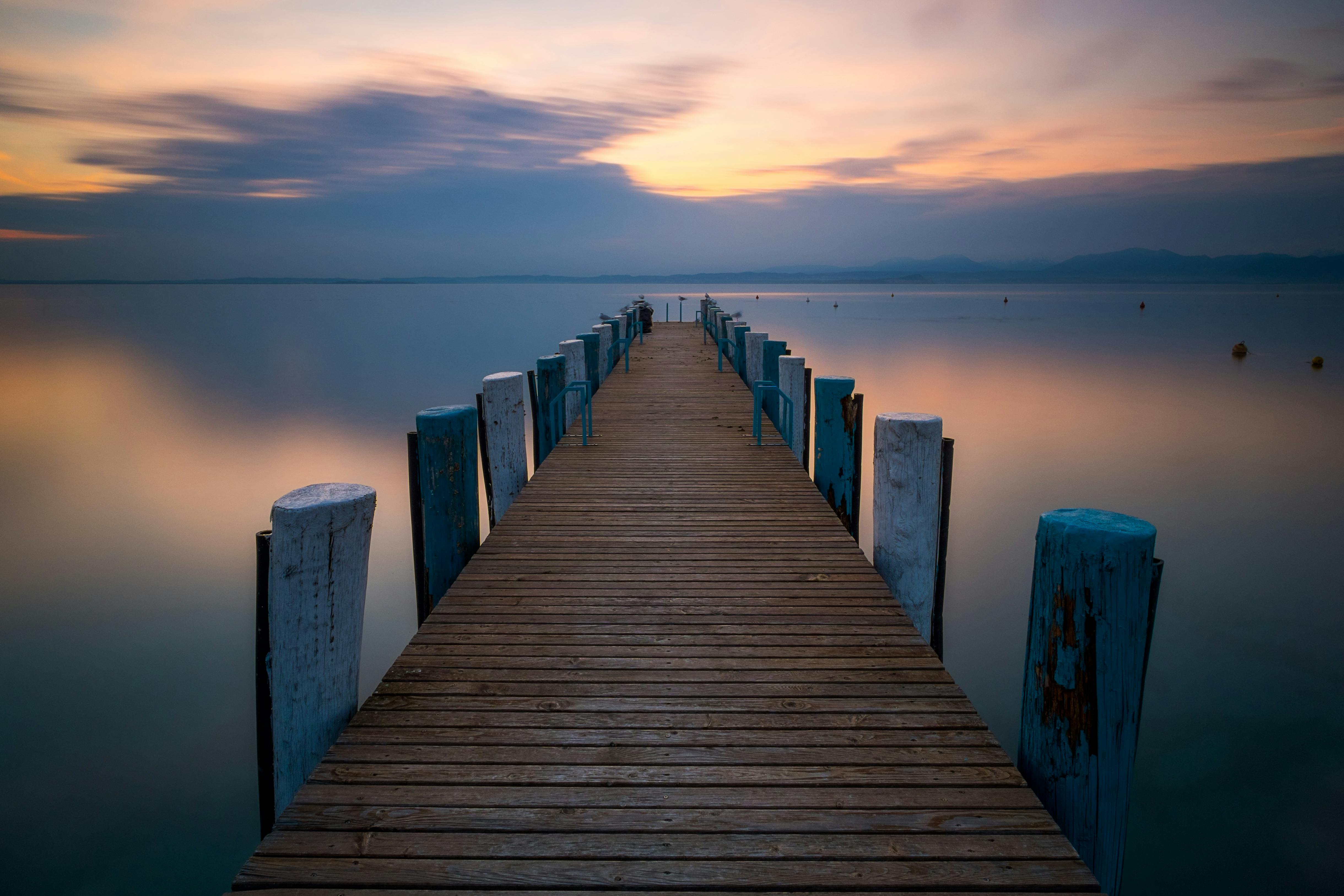 Pier over Water at Sunset · Free Stock Photo