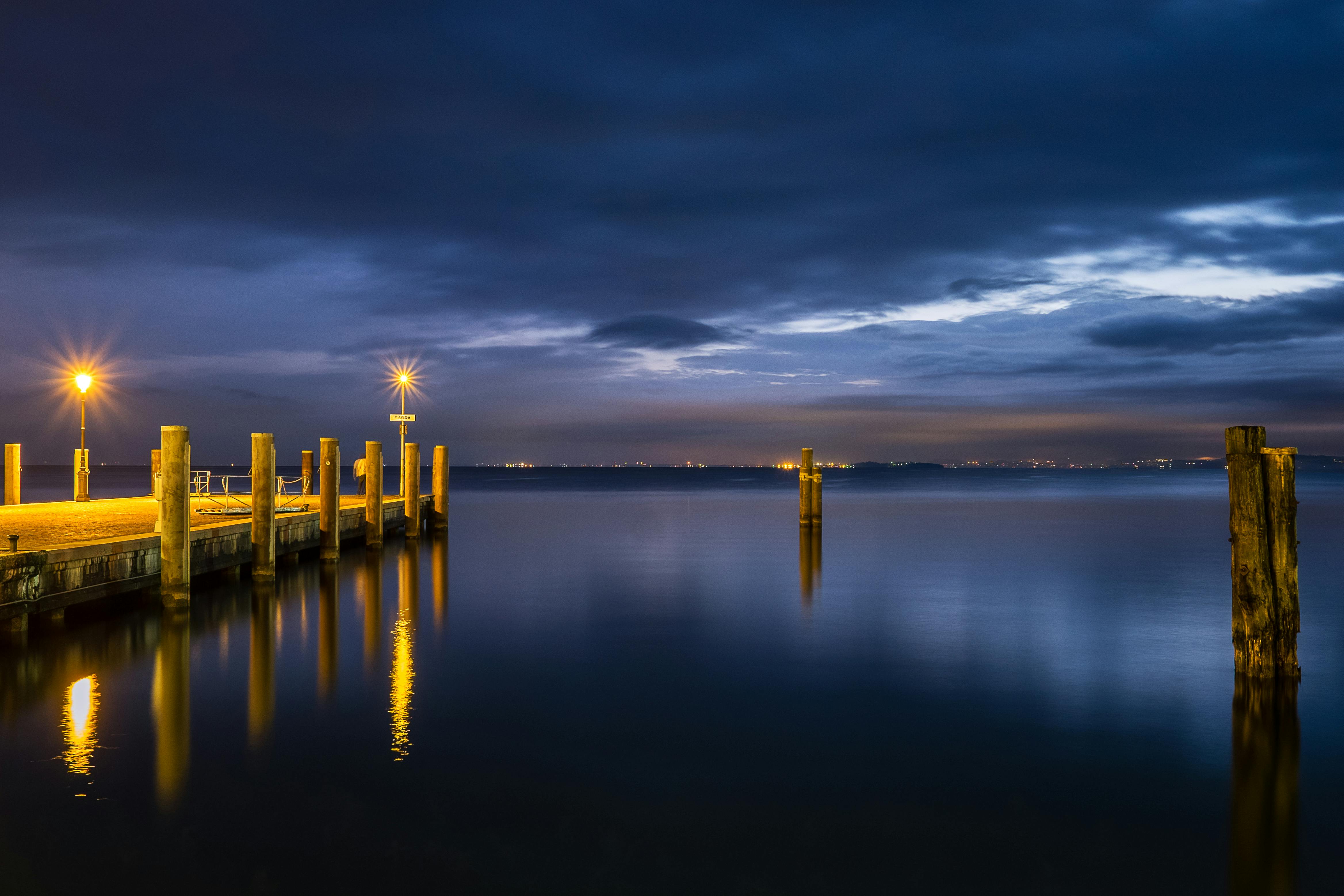 Lights on a Pier and the Sea · Free Stock Photo