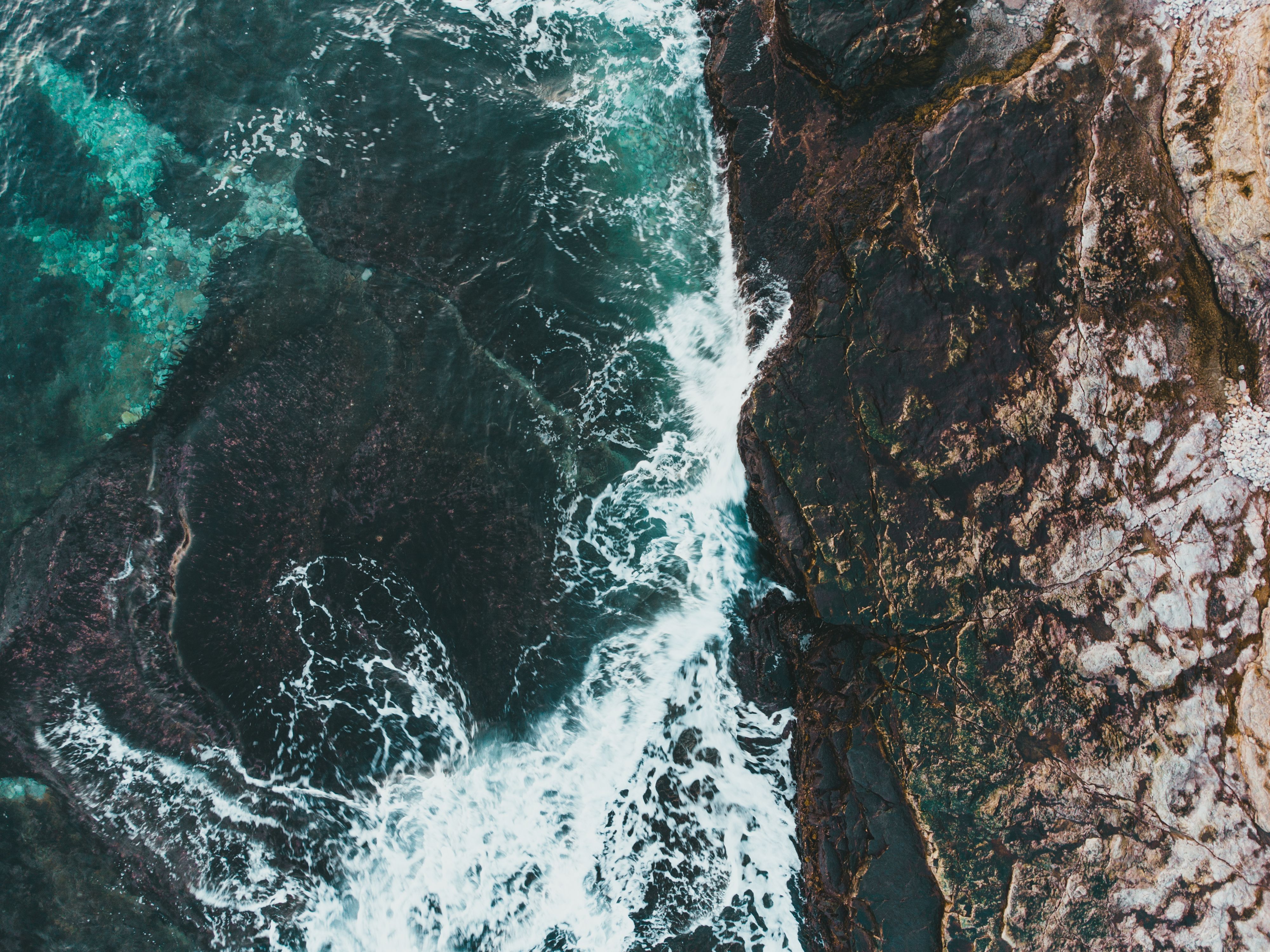 Rough rocks near sea with pure water · Free Stock Photo
