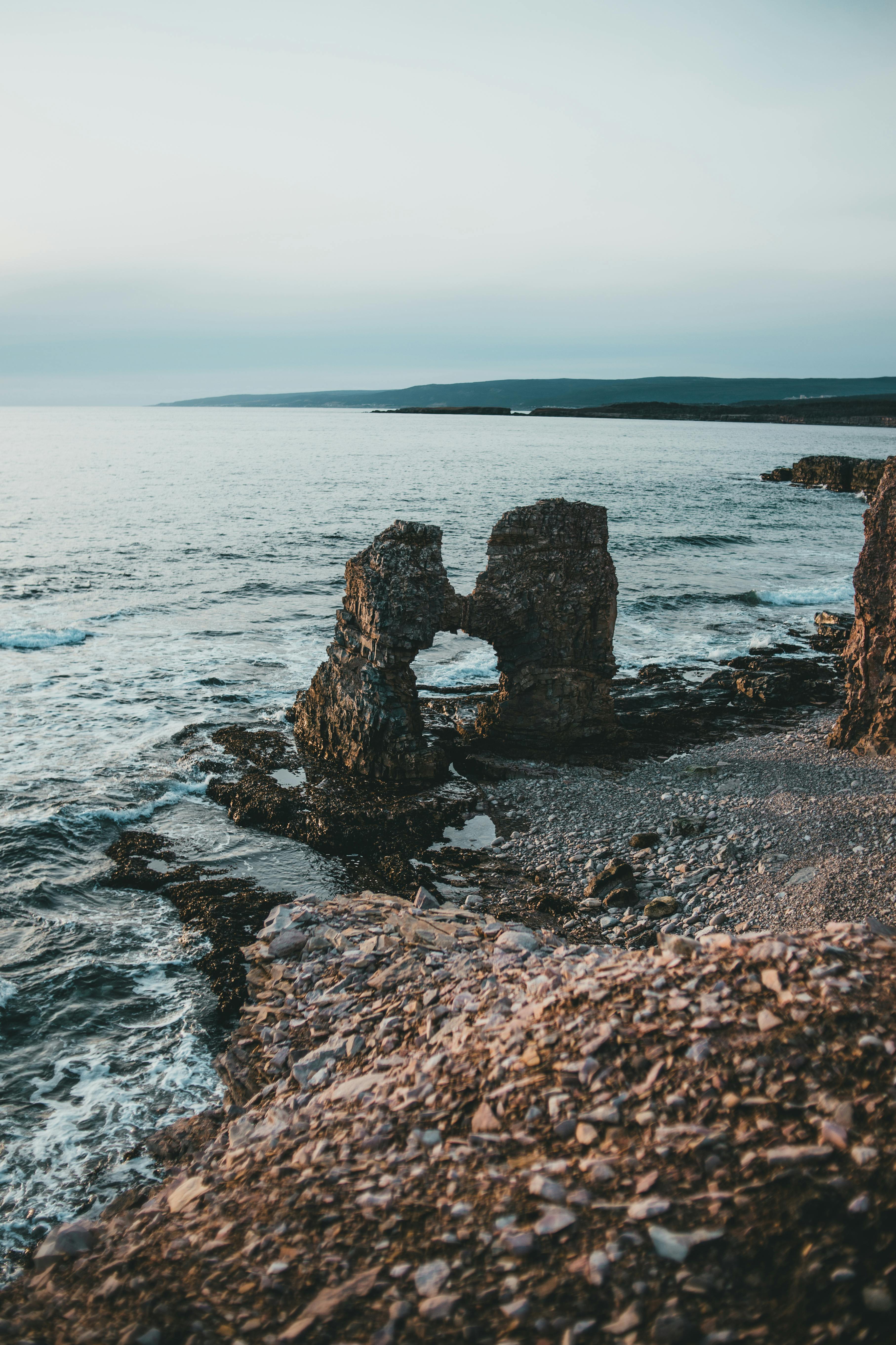 Rocky Mountain Beside Body of Water · Free Stock Photo