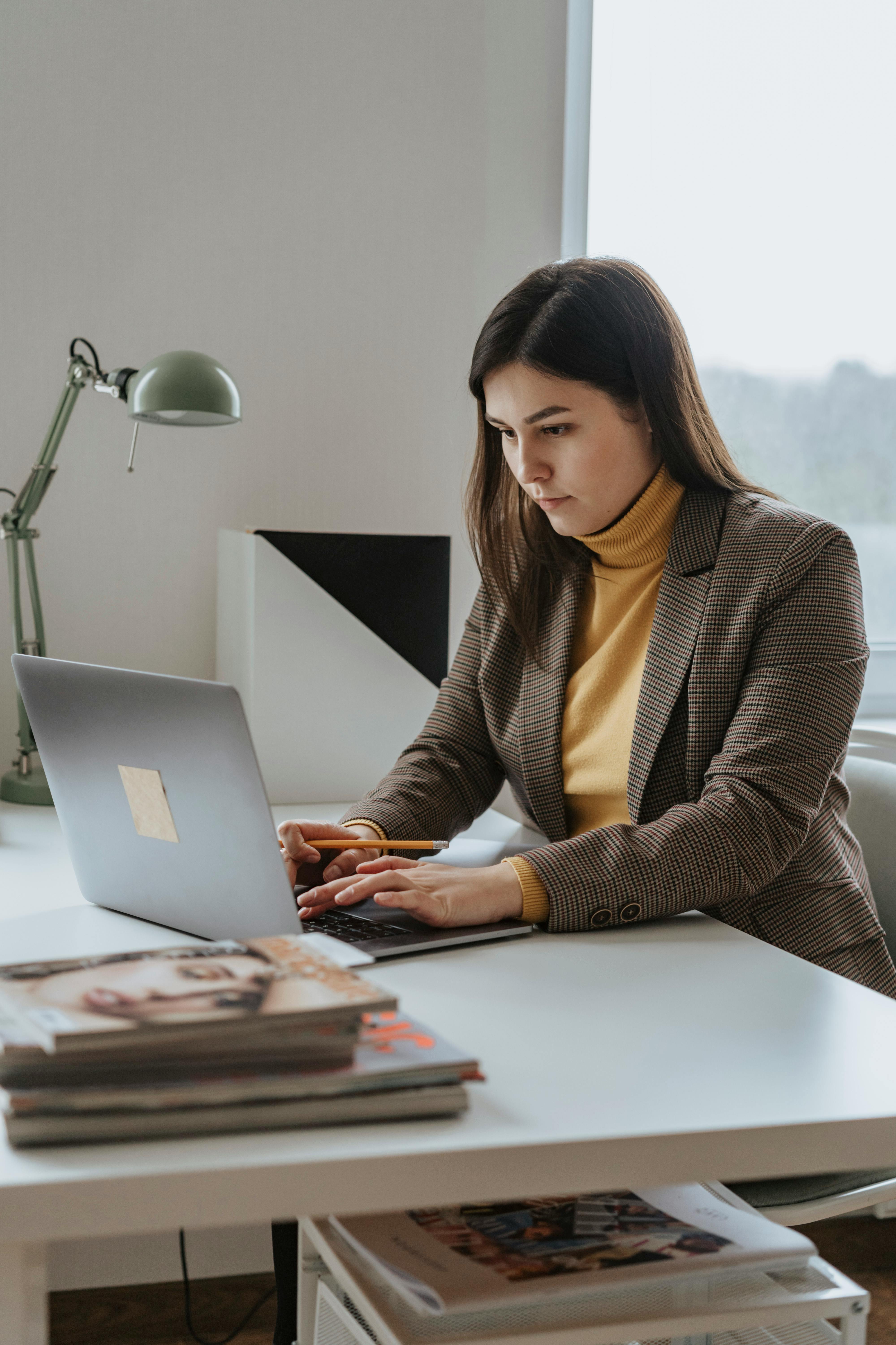 A Woman Typing on a Laptop · Free Stock Photo