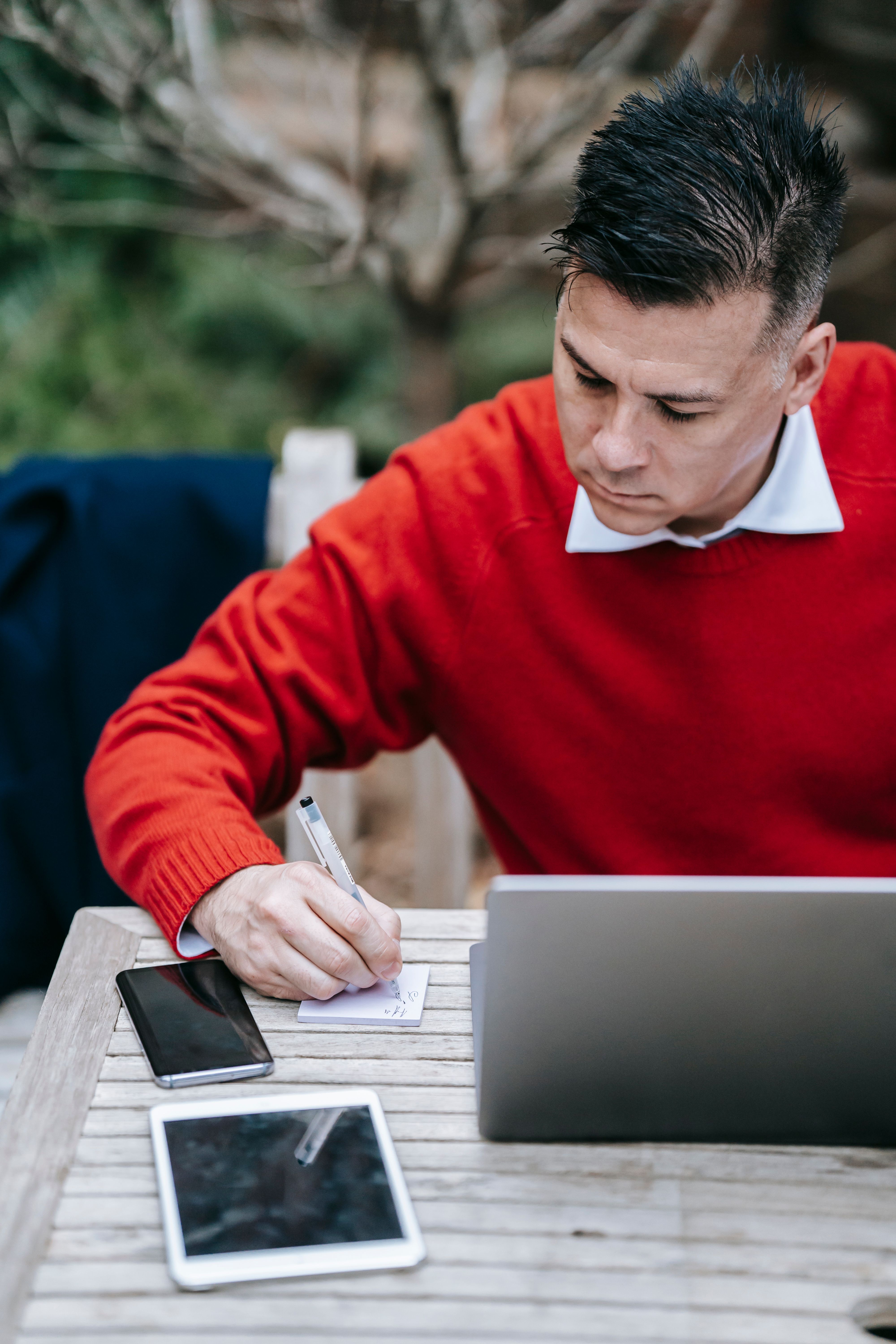 Photo Of Man Writing On A Piece Of Paper · Free Stock Photo